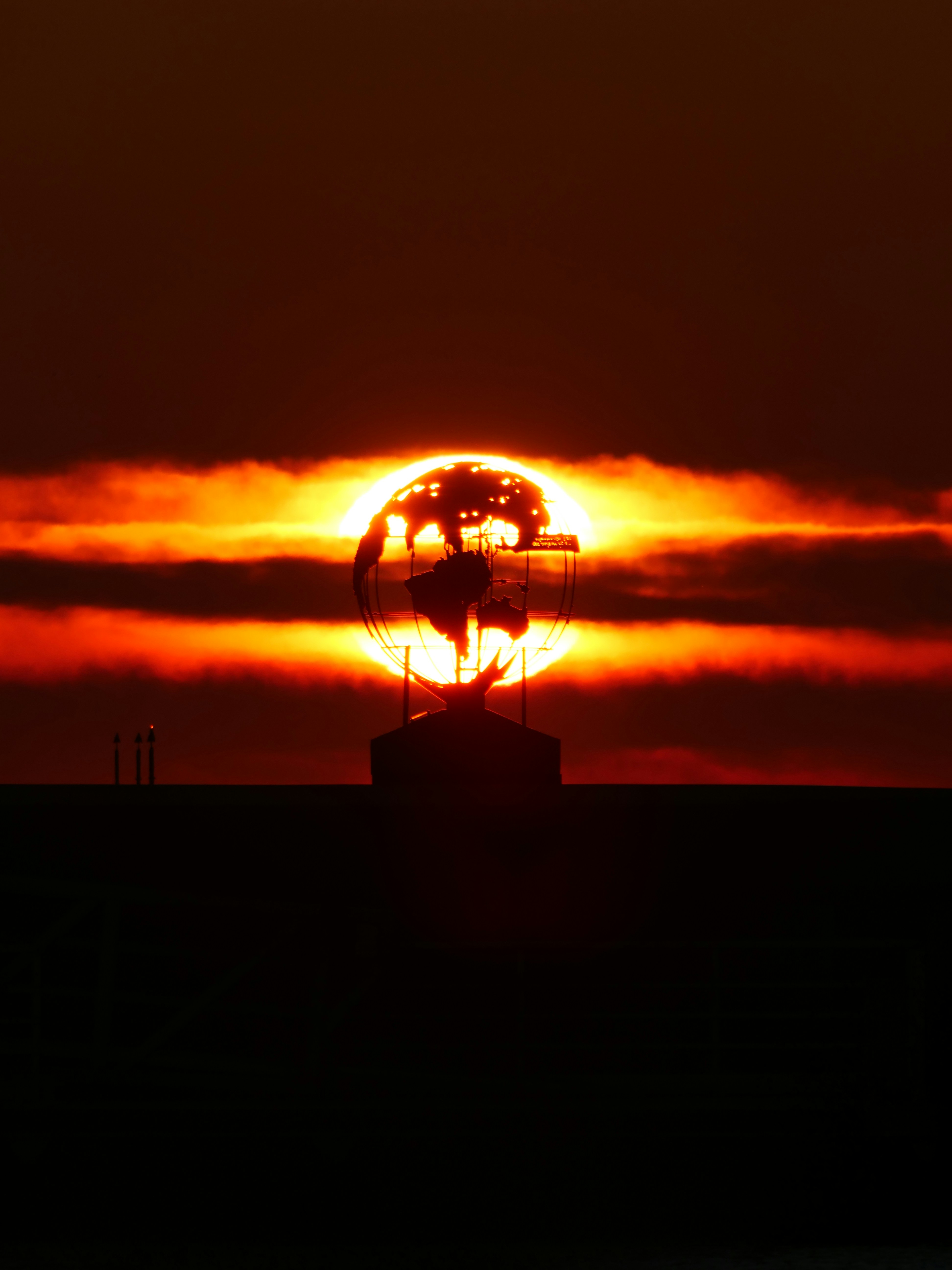 Solar Sculpt: The Globe Spinning Above a Rooftop