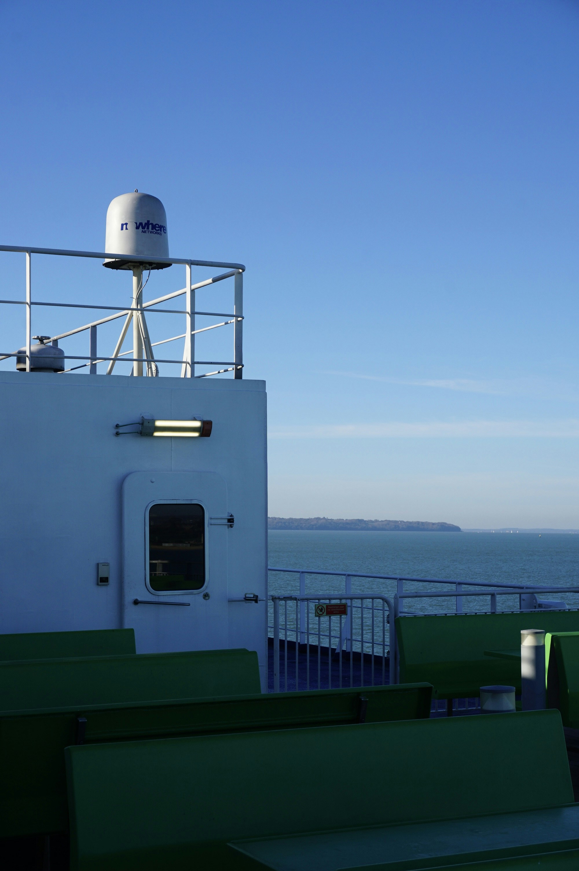 Airport-class Vessel: White Deck and Blue Sea Under Clear Sky