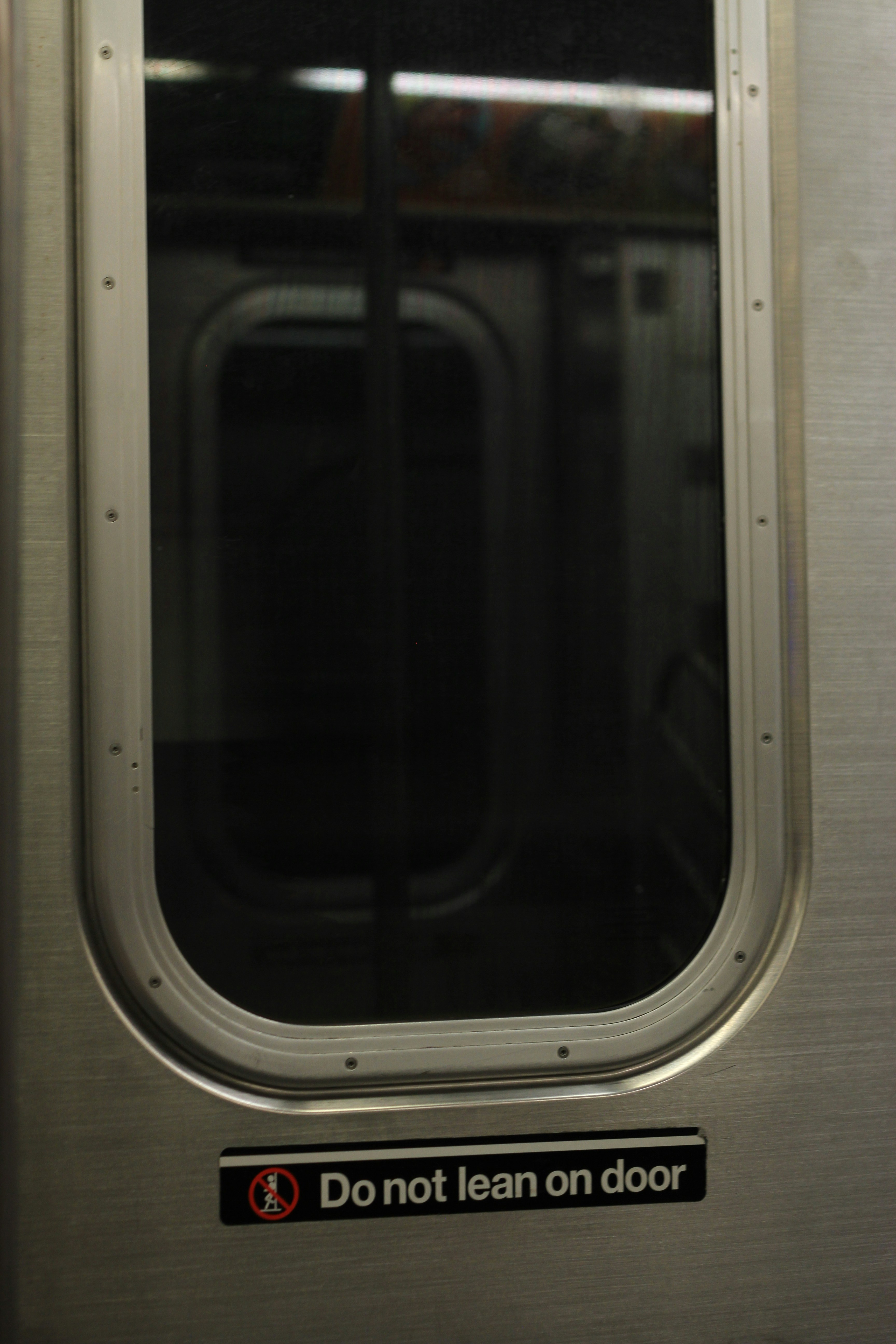 Industrial Window: A Transit Car Window Framed by Steel and Silence