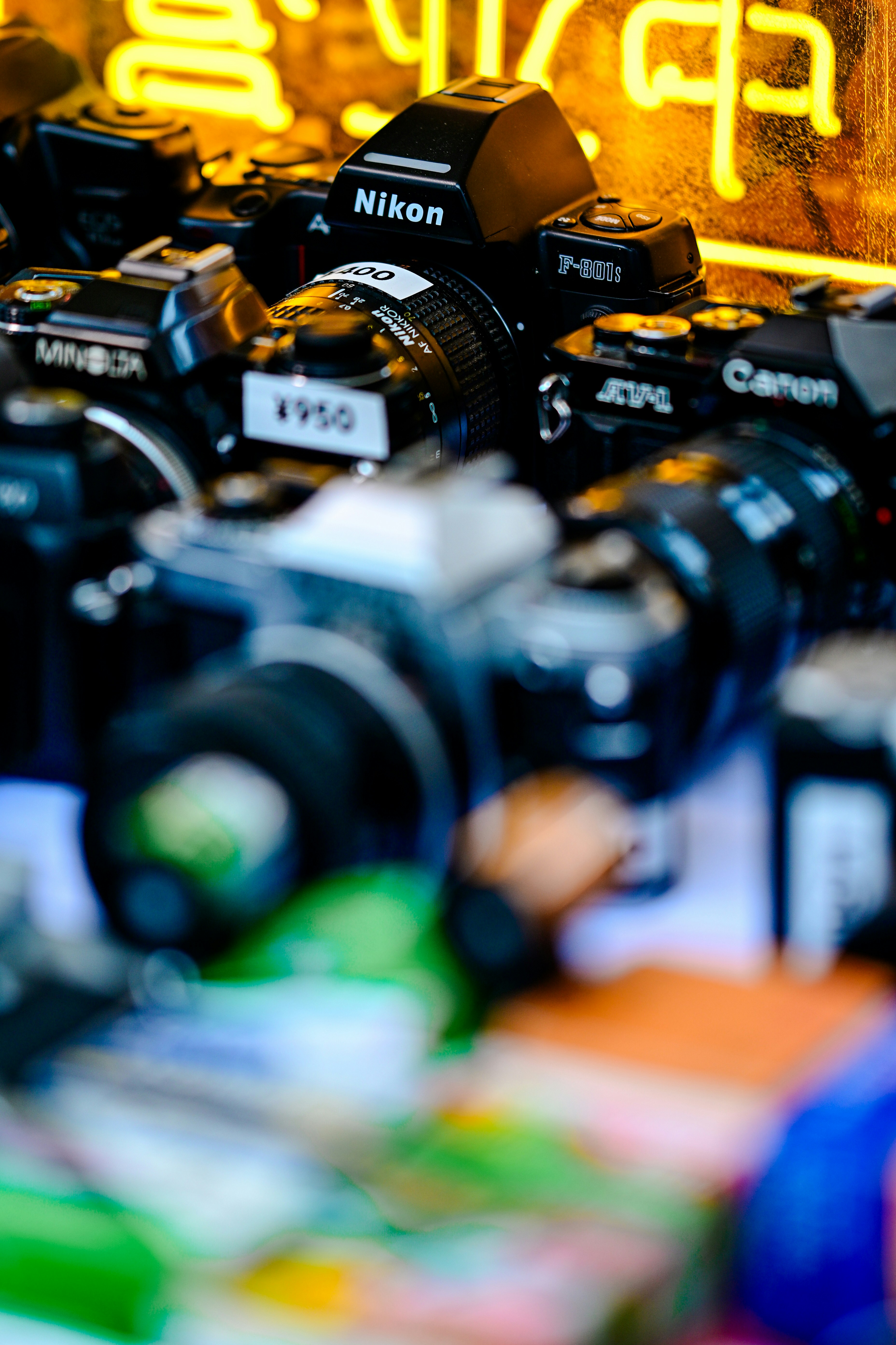 Nikon cluster: a neon glow framing a row of vintage cameras