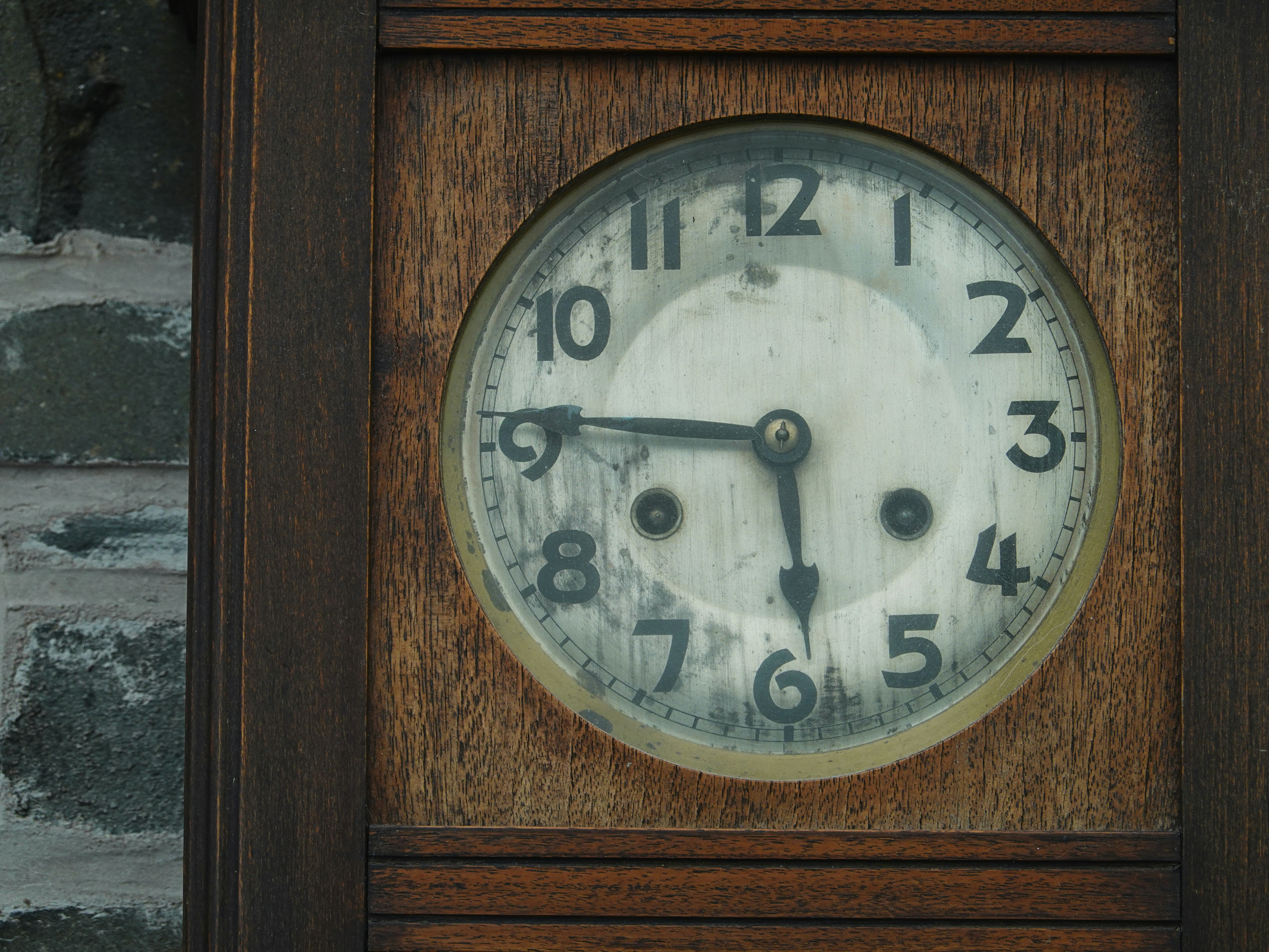 Timeworn Precision: The Clock Nestled in Weathered Wood
