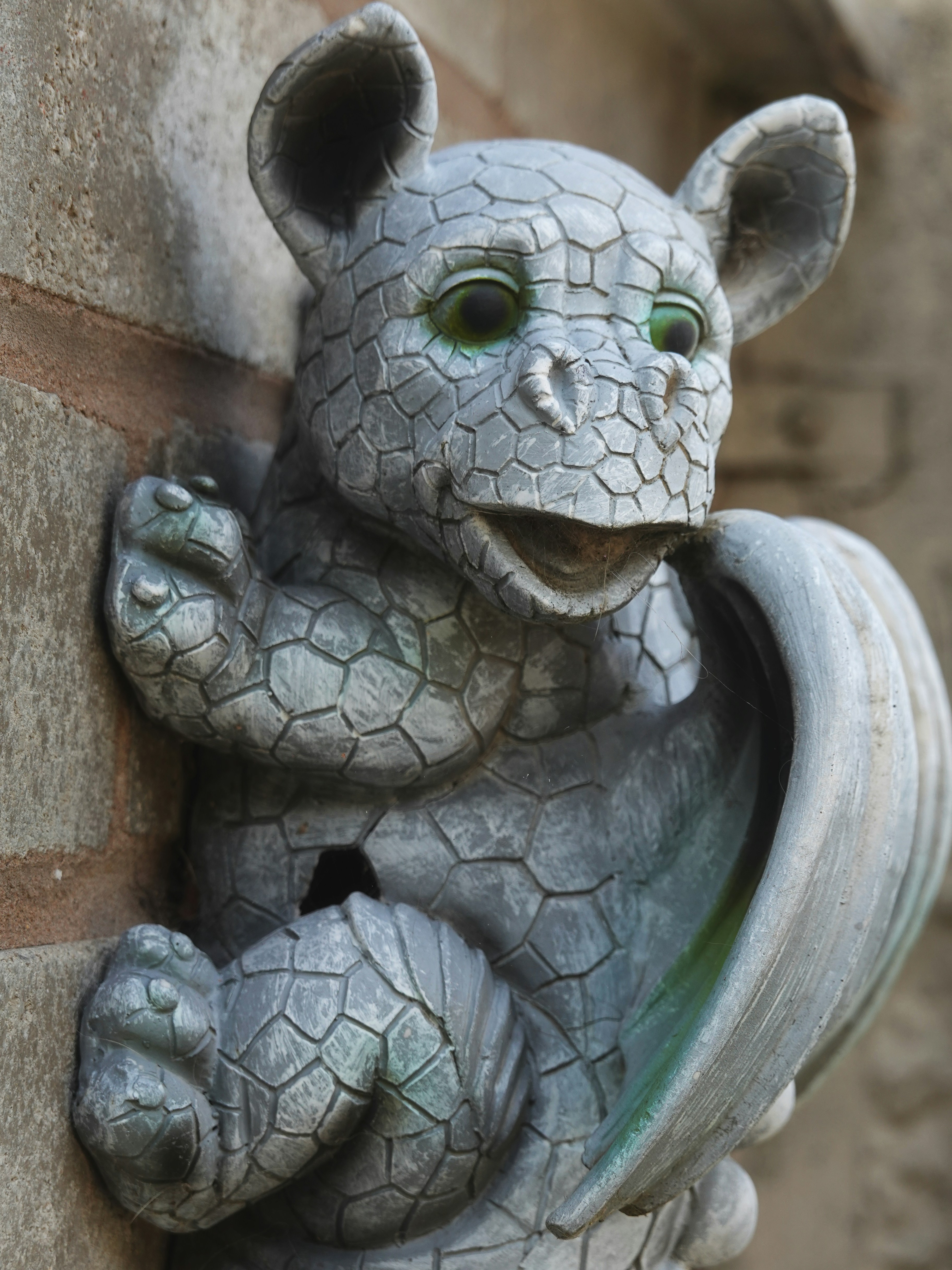 Stone Chimera Grins from a Brick Ledge