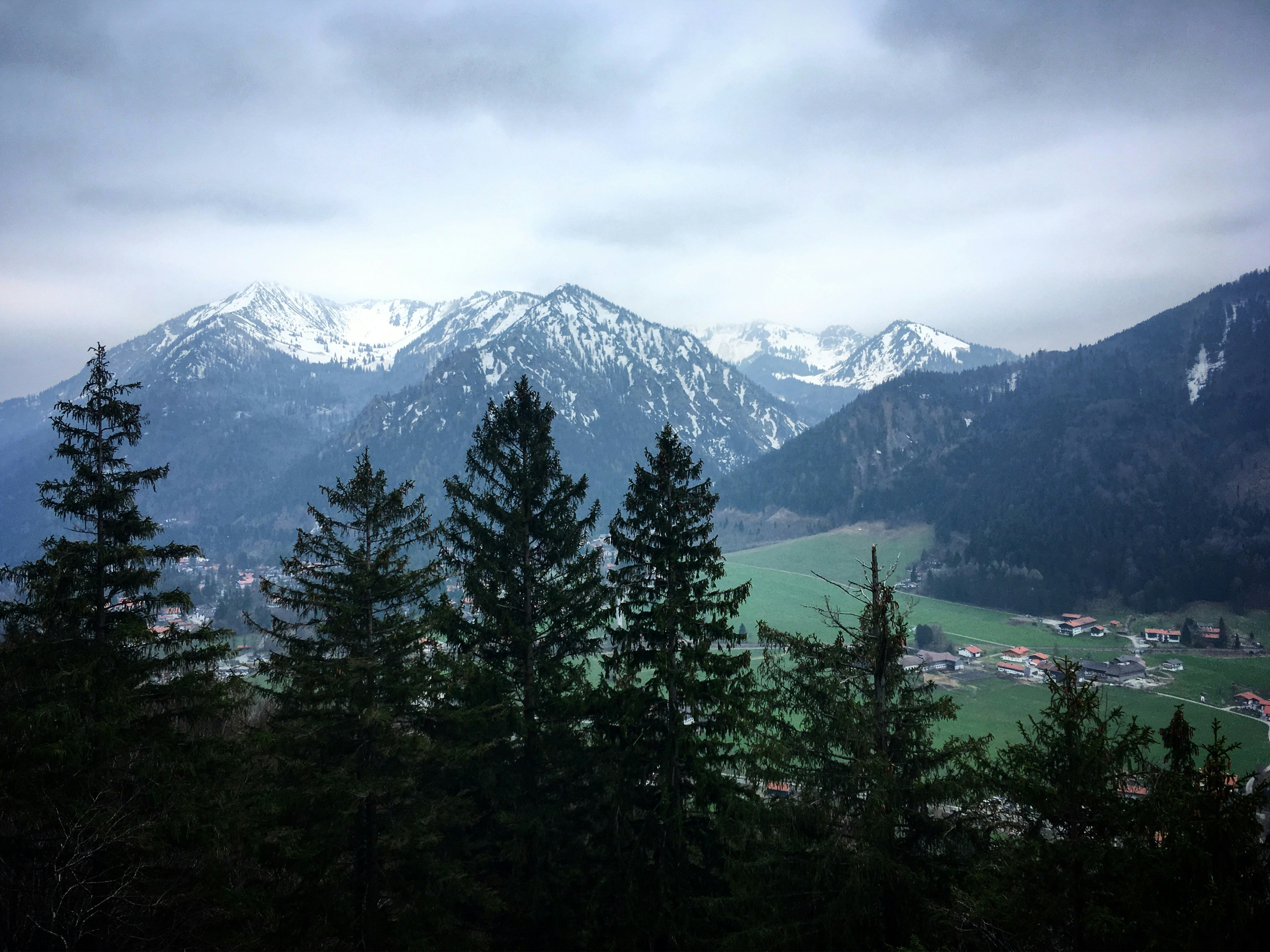 Snow-dusted peaks over a pine-fringed valley