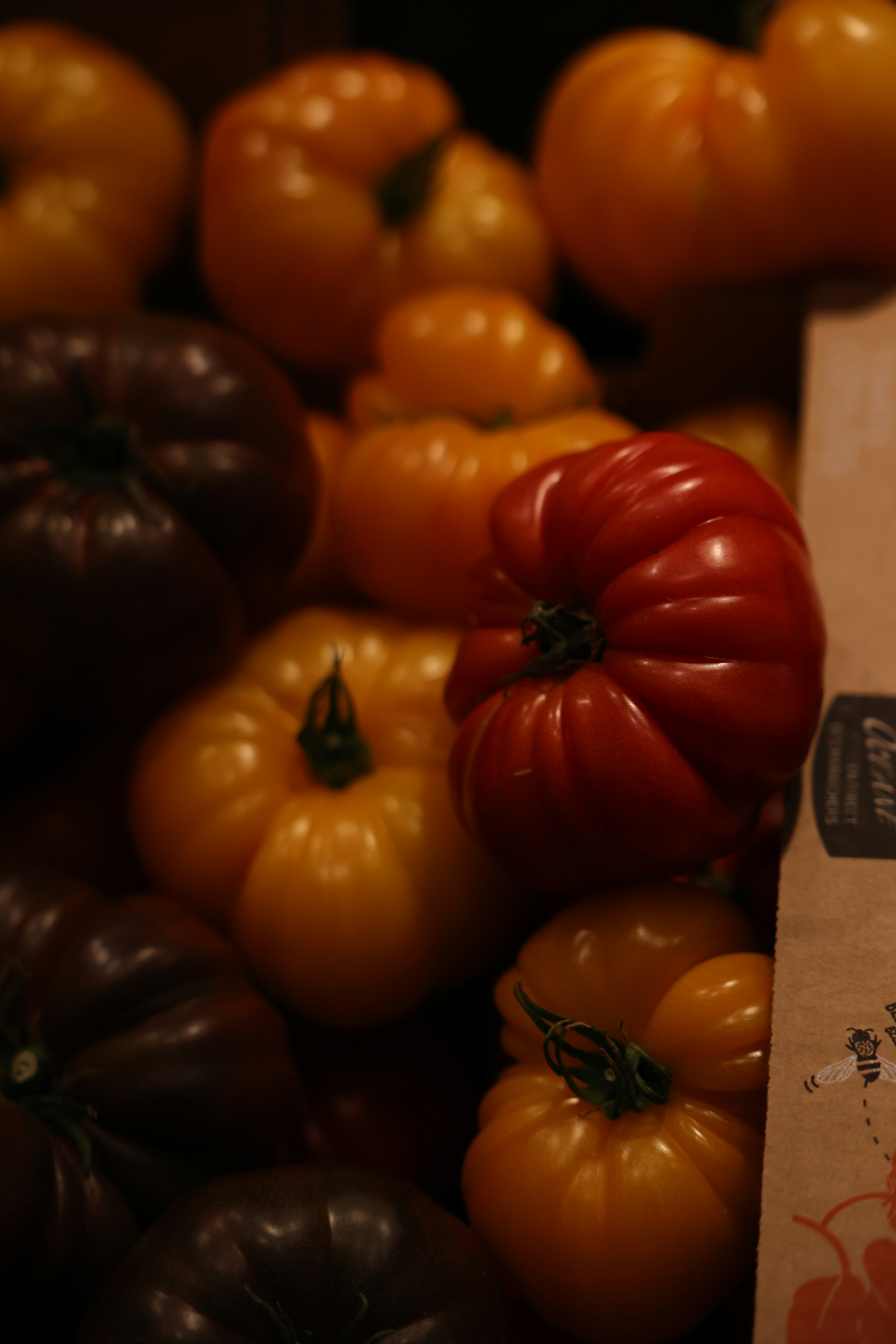 Red heirloom tomato cluster crowns a shelf of autumn tones