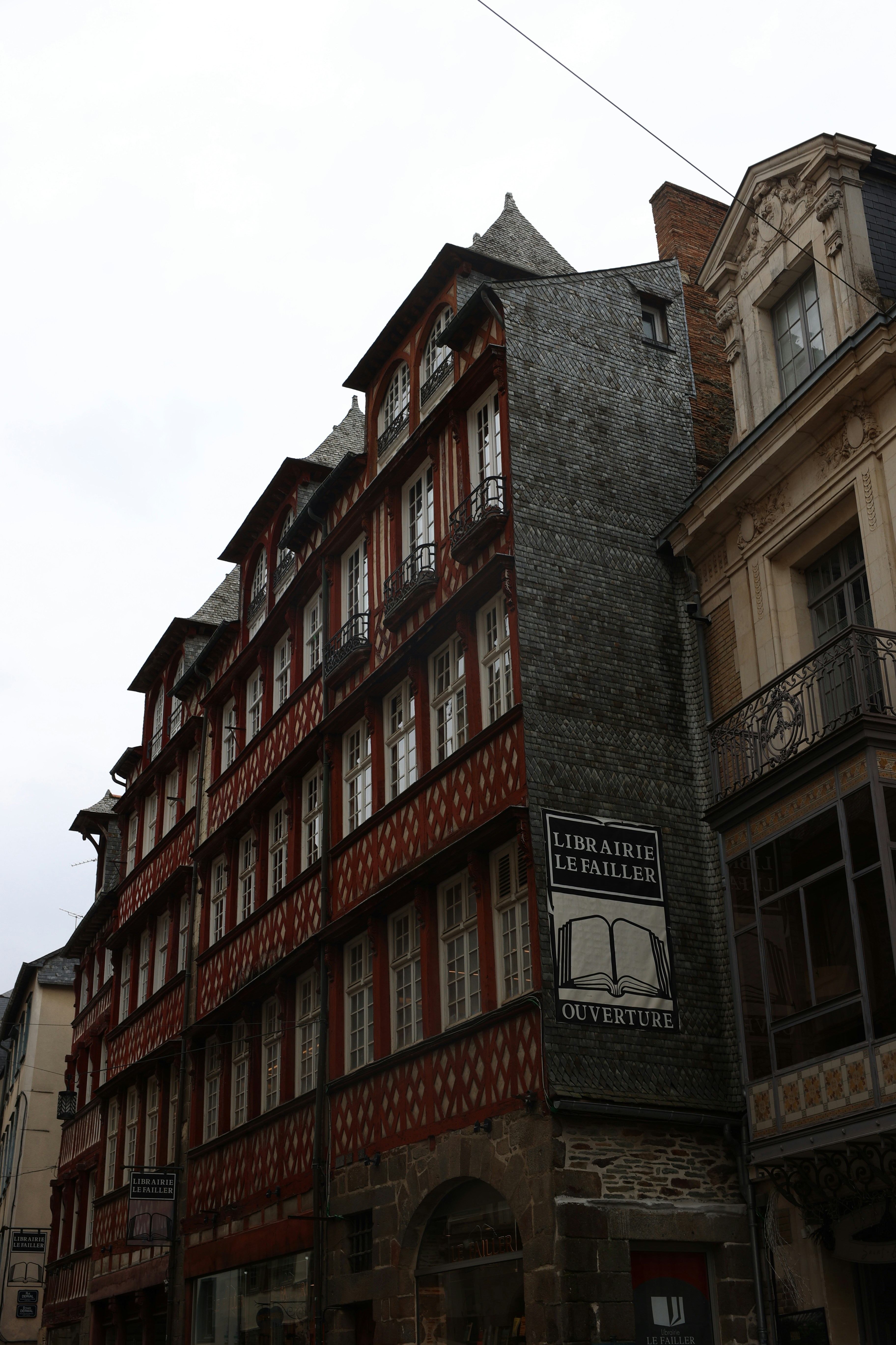 Brick-and-Slate Facade: A Historic French Rue Building Rising Along the Street