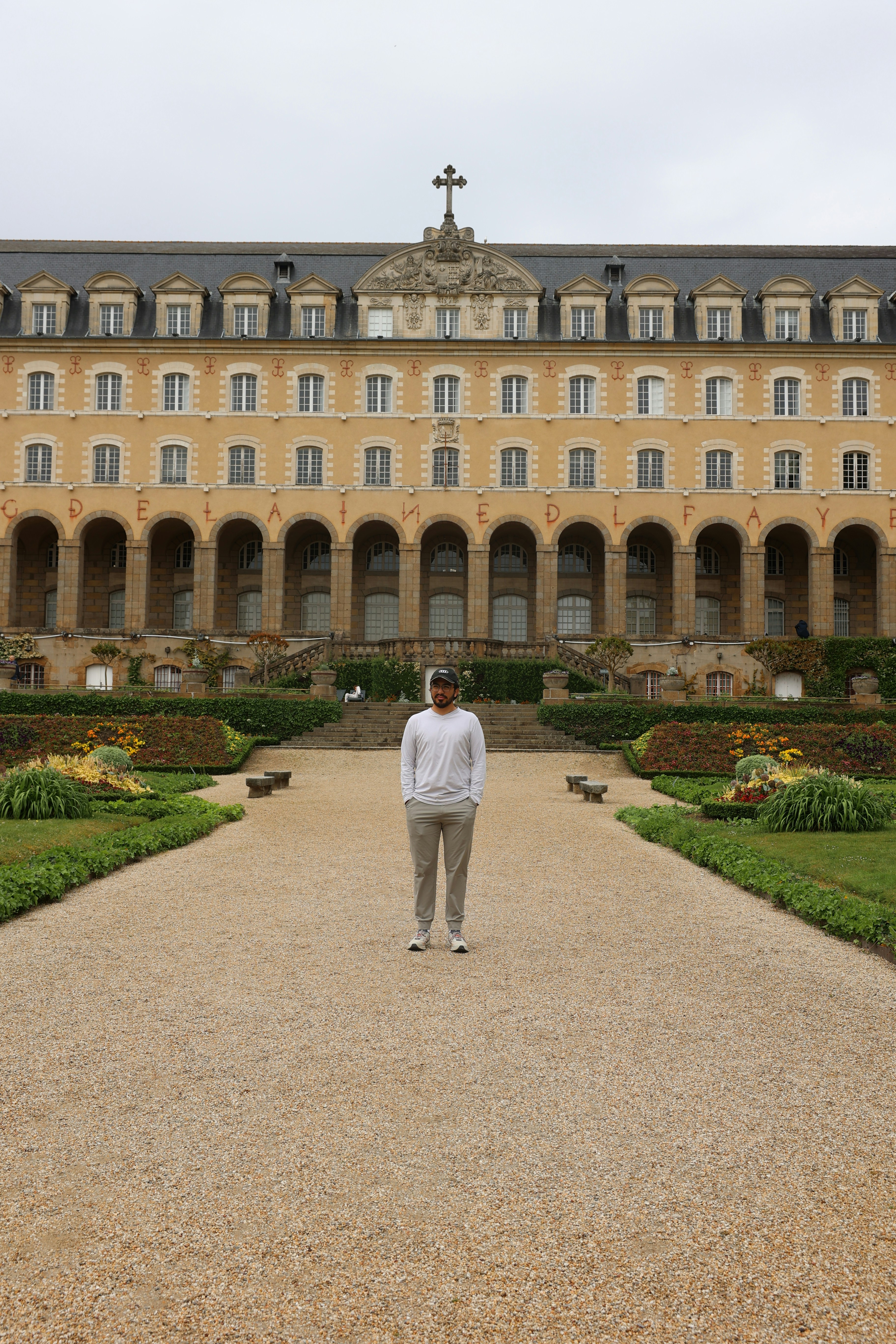 Visitor in the Courtyard of a Historic European Monastery