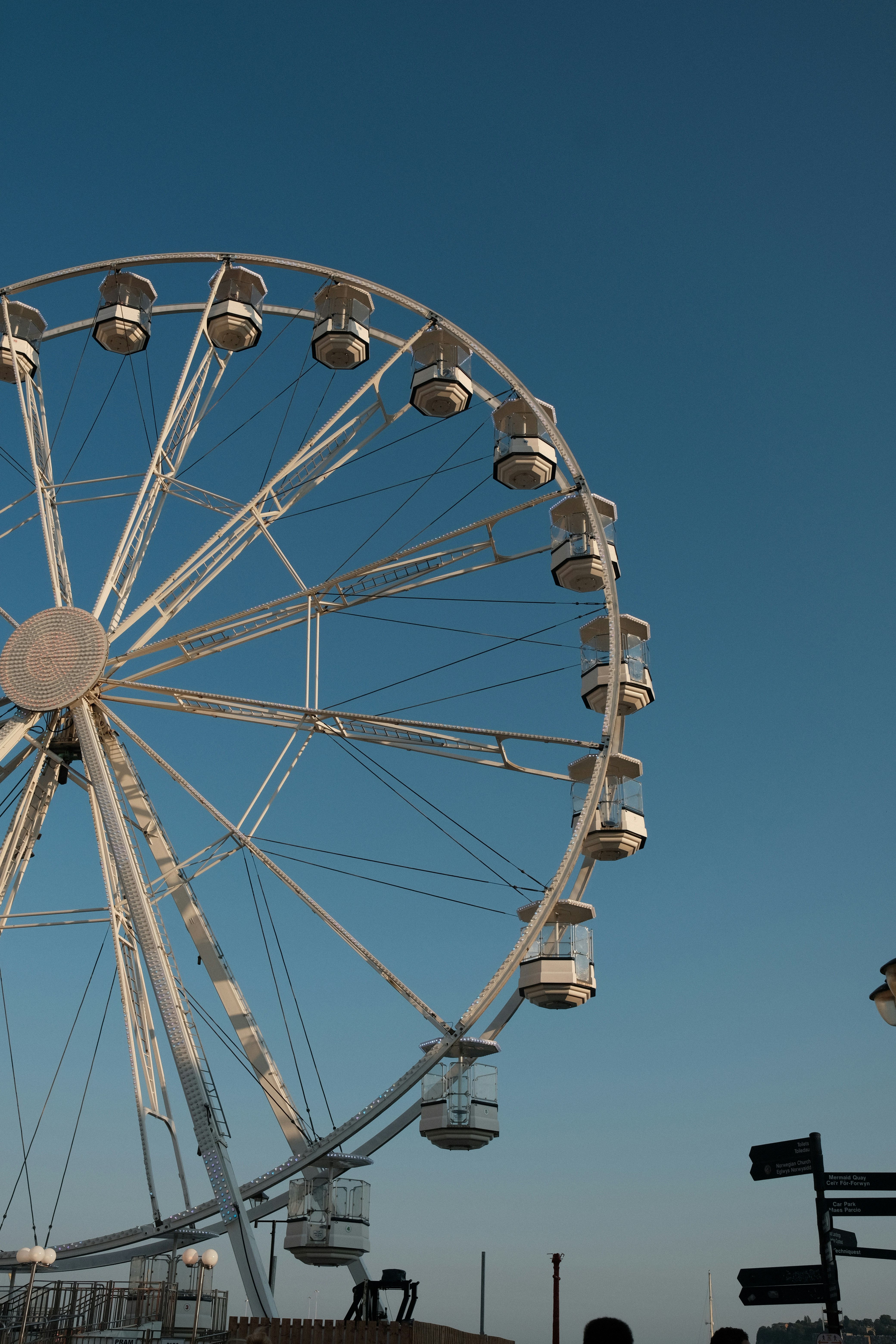 Ferris Wheel Silhouette Against a Clear Coastal Sky