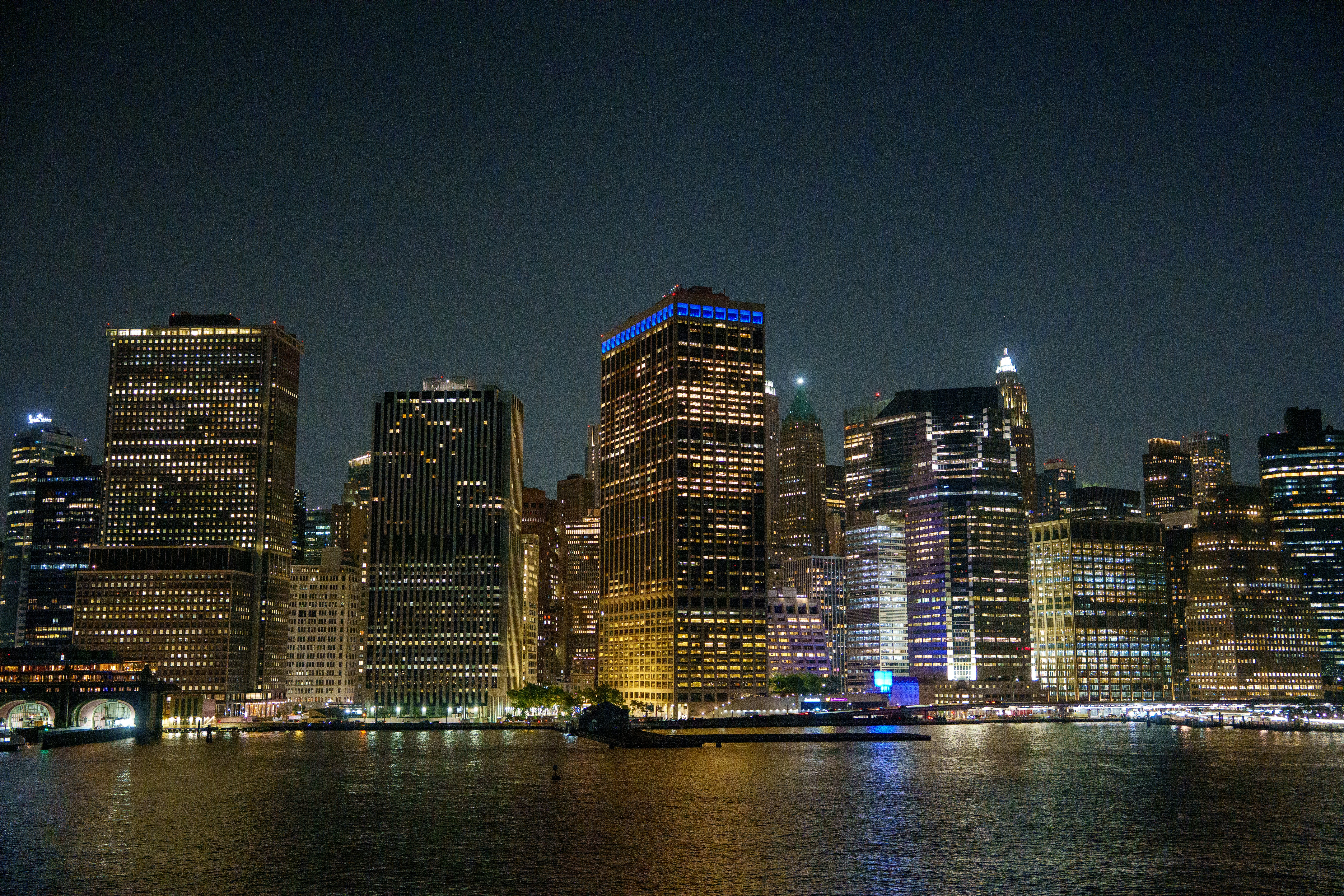 Neon Waterfront: Midnight City Skyline Adrift on the River
