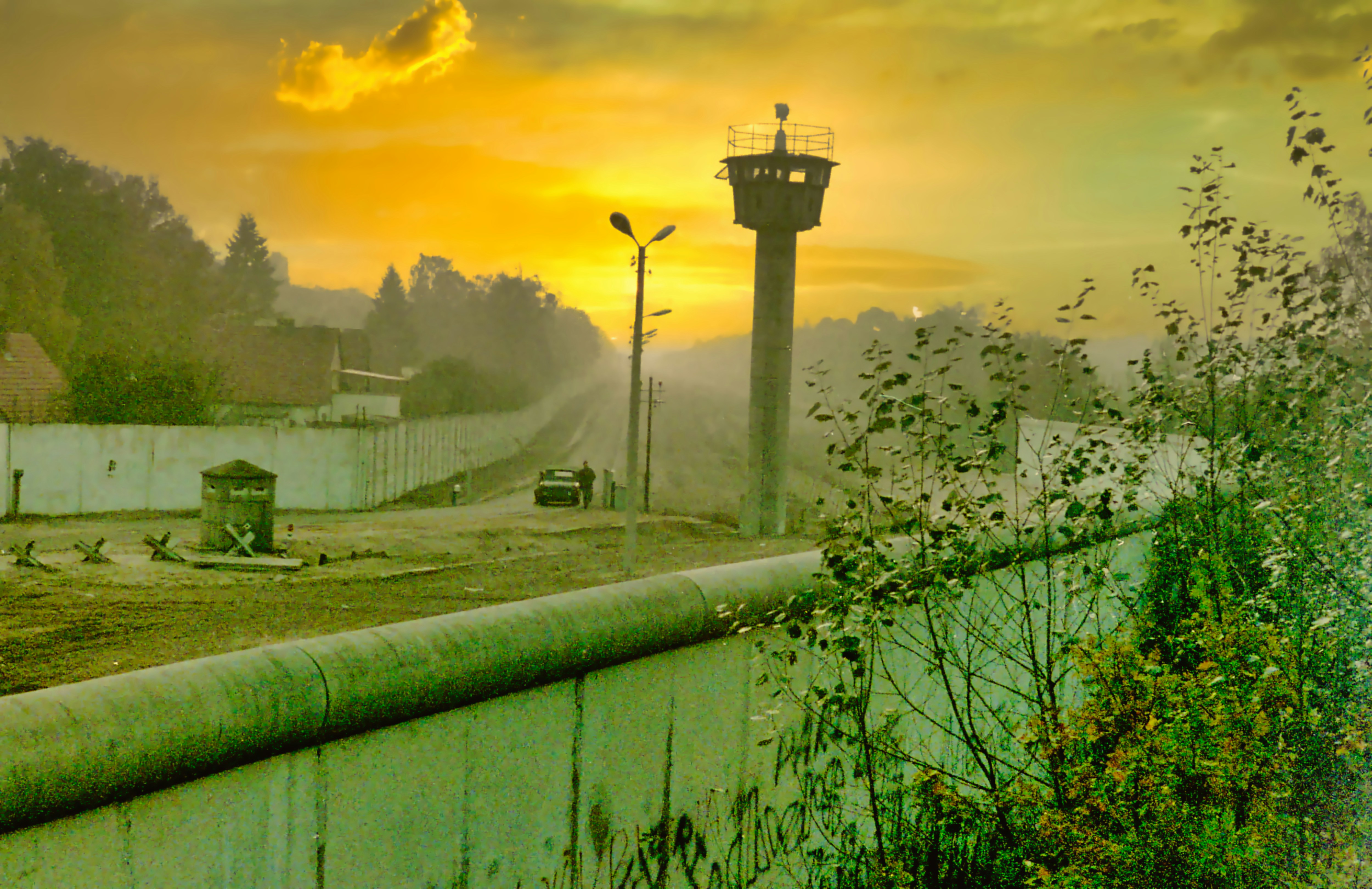 Sunlit Border Fence and Watchtower in Quiet Perimeter