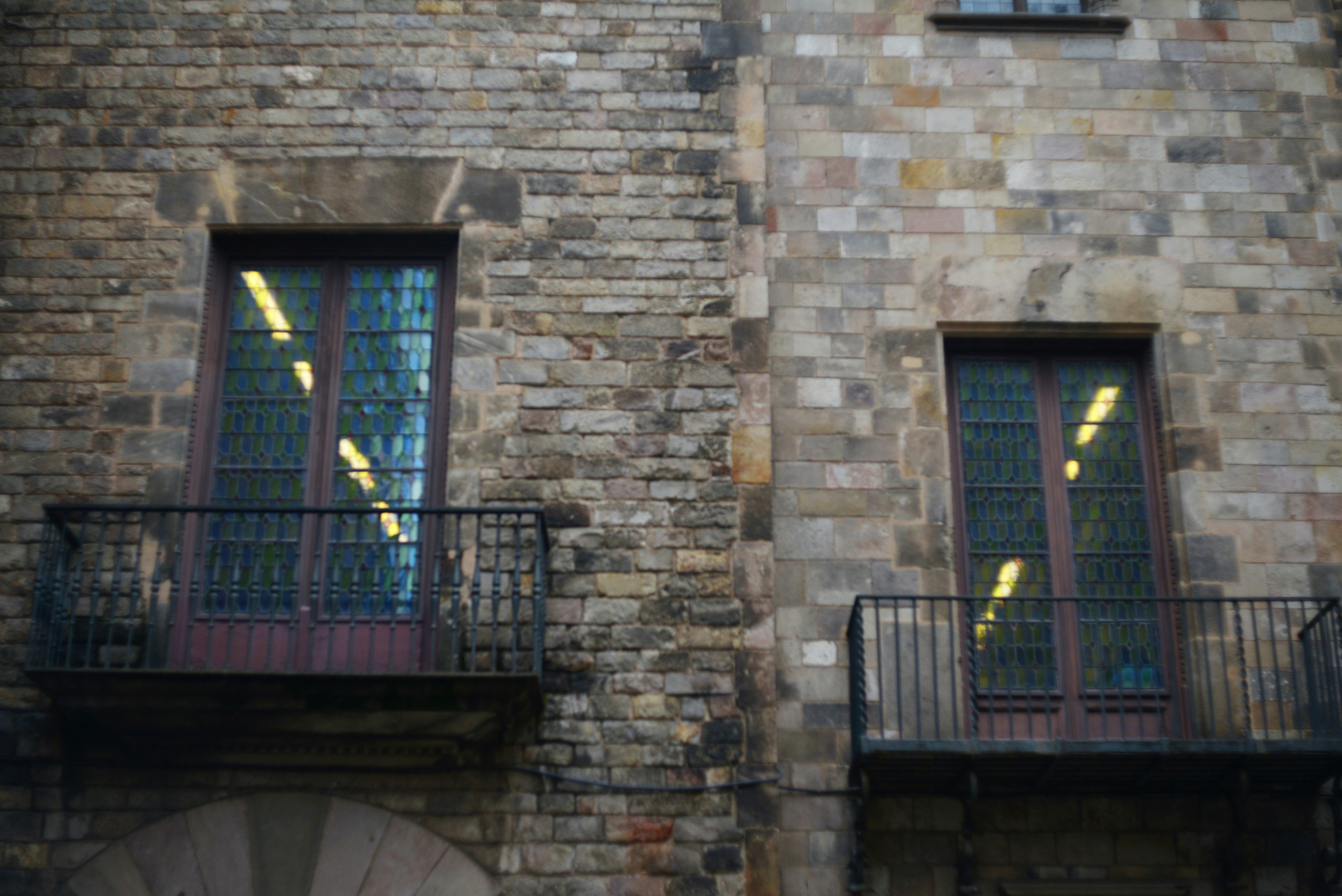 Stone Facade with Twin Windows and Subtle Light Trails