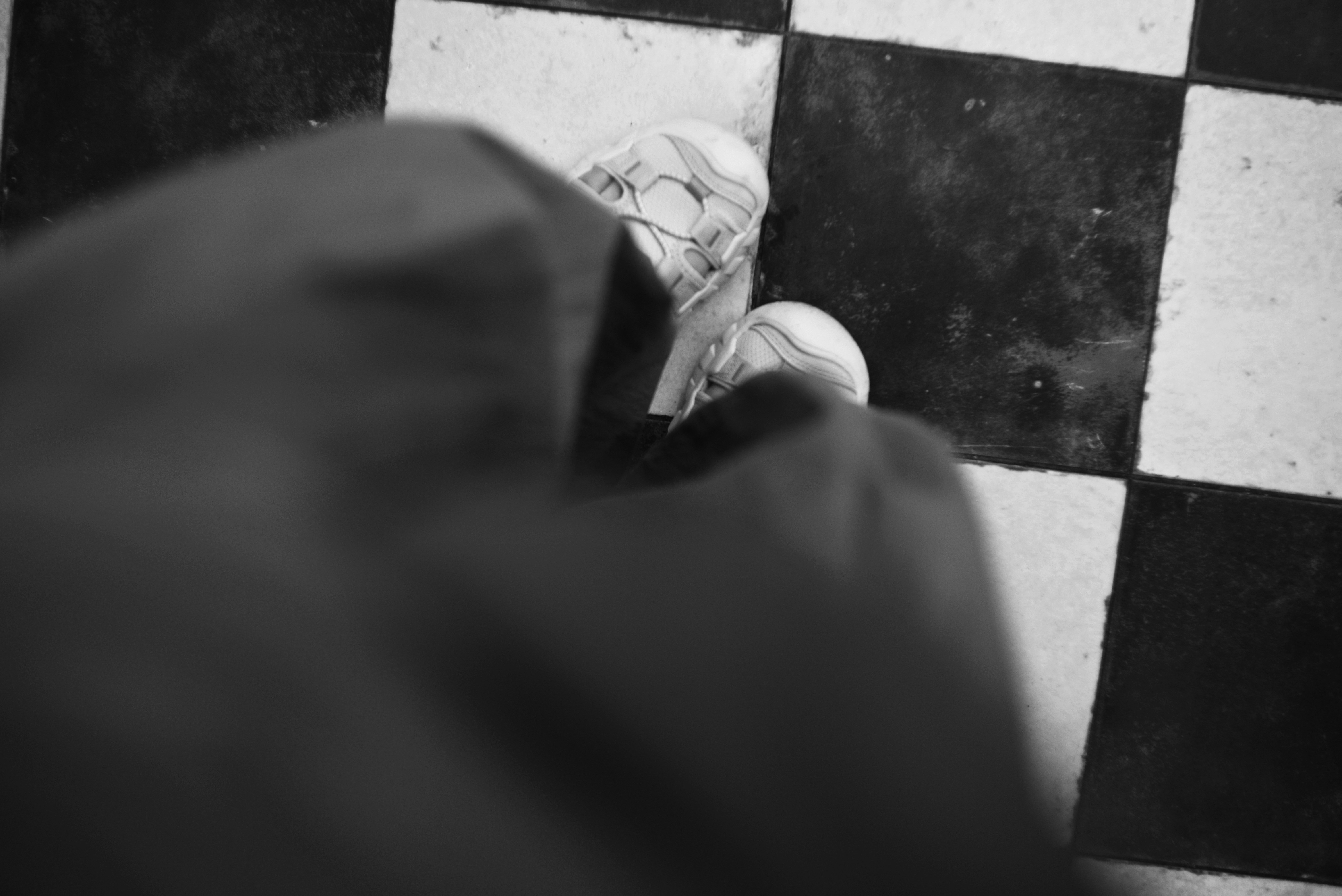 Faded Steps: Shoes and Checkerboard in Motion