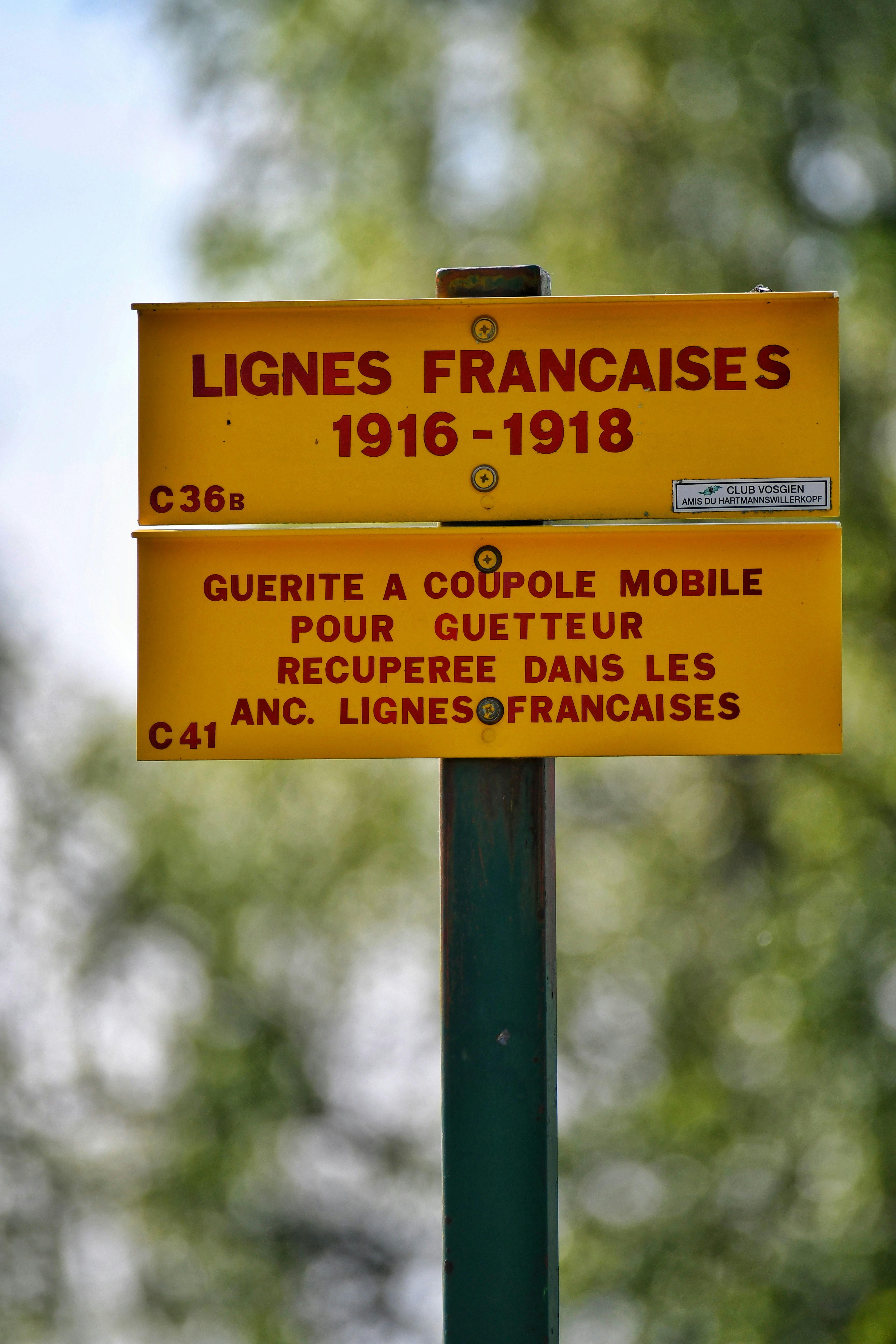 Yellow Signpost in French Railway Landscape