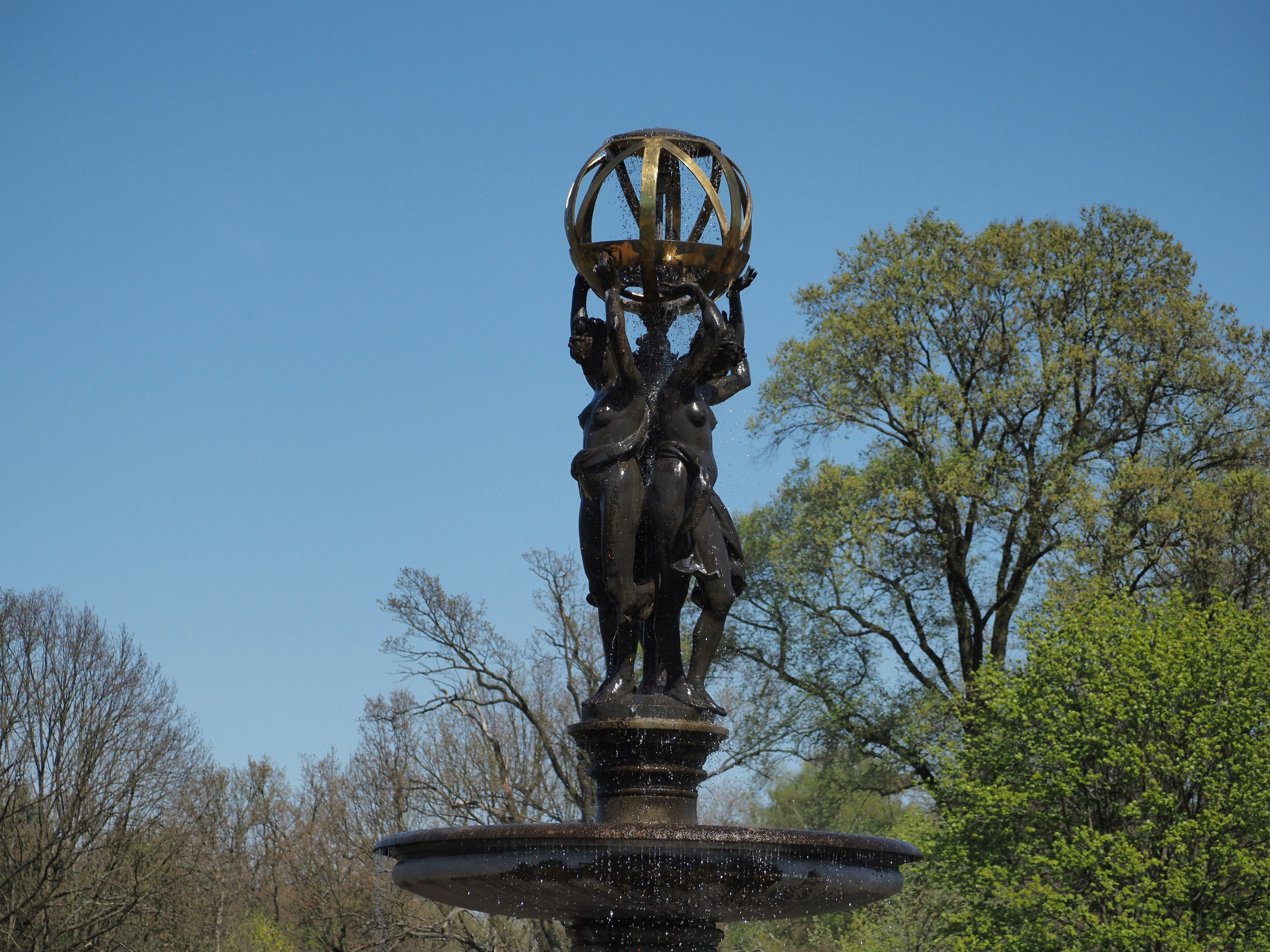 Globe of Atlas: Bronze Statue Soaring Above a Fountained Pedestal