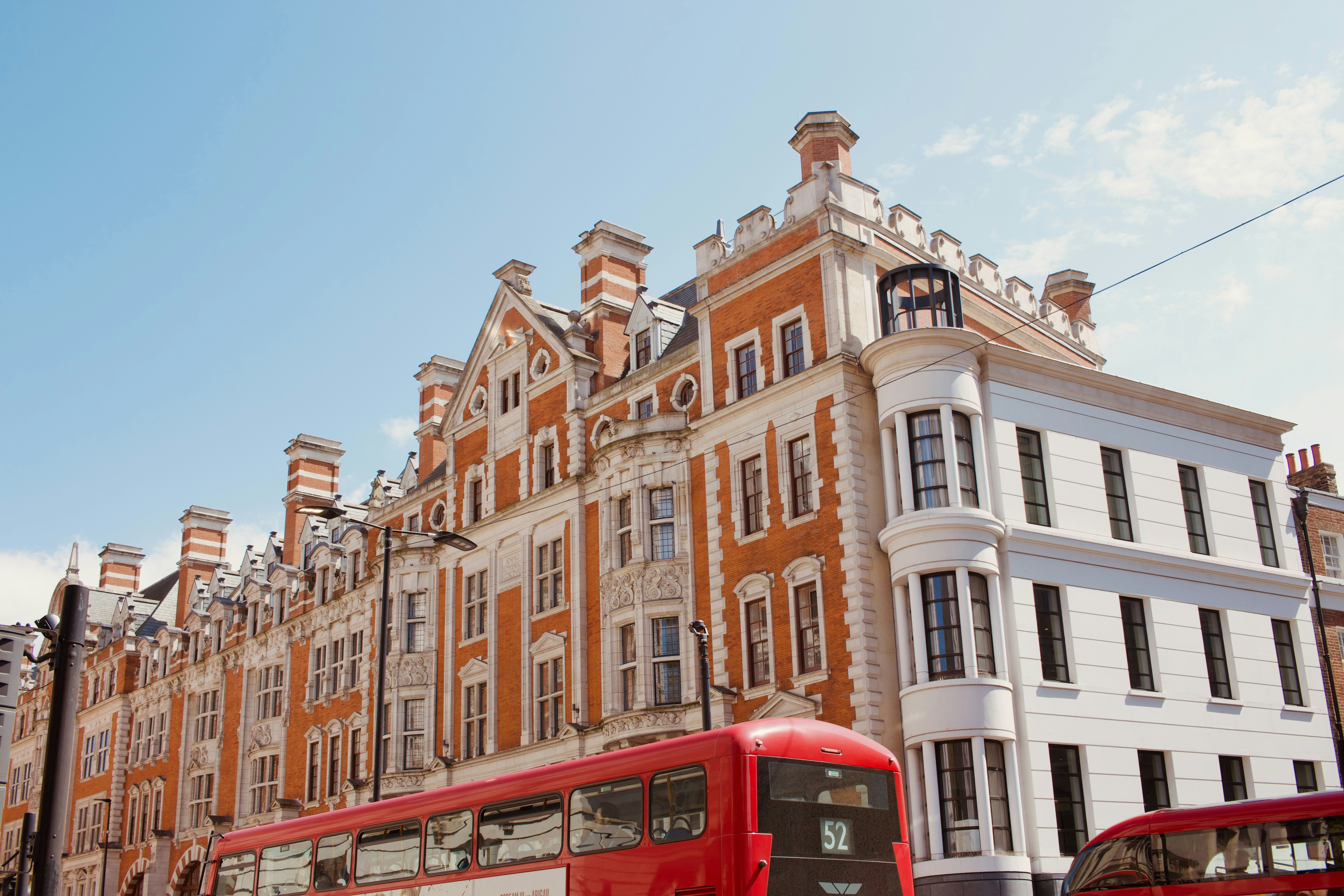 Brick Gothic Facade and Red Bus Line in a London-style Street