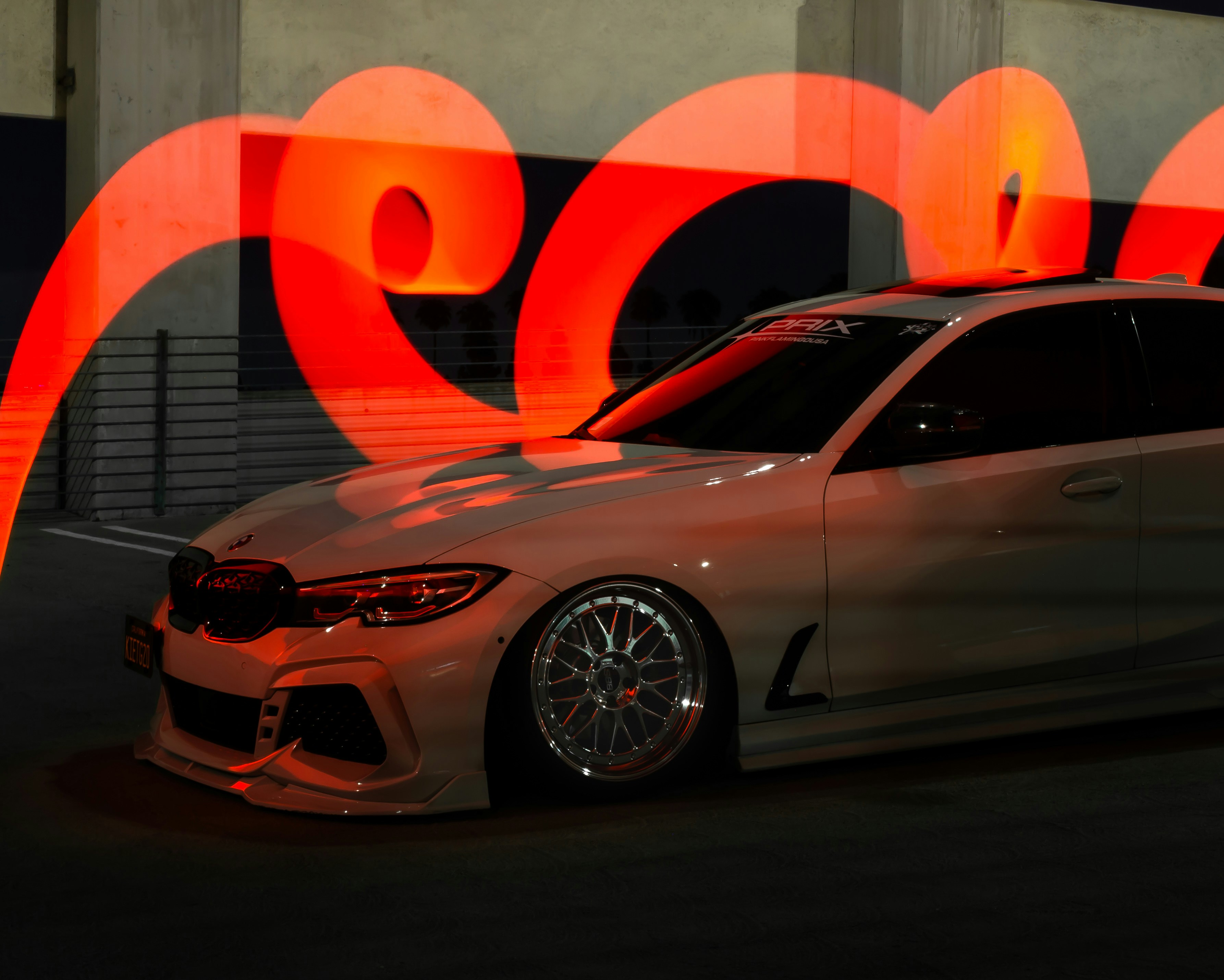 Neon Streaks Over a Low-slung Drifted Sedan
