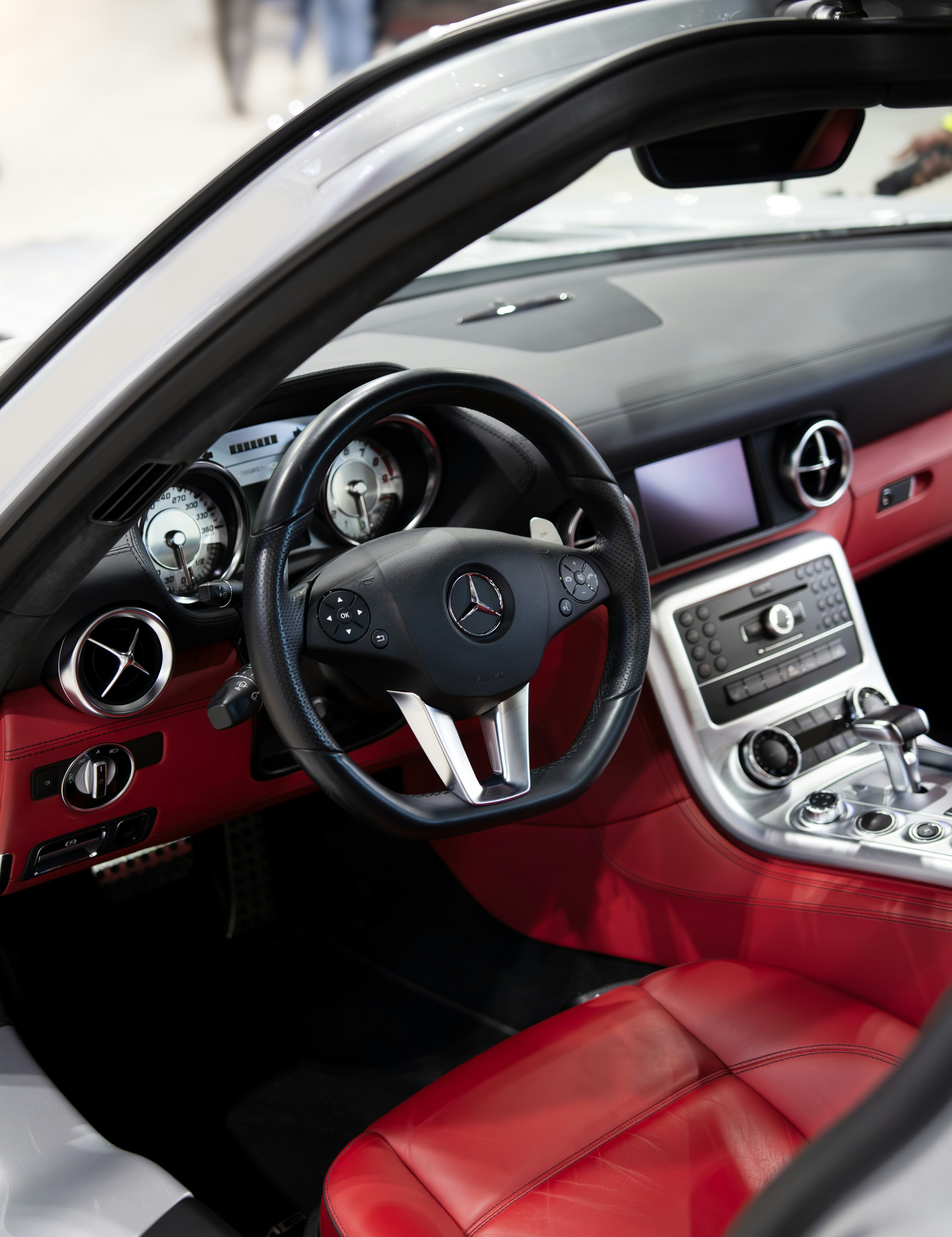 Luxury at Hand: Red leather and chrome cockpit of a Mercedes