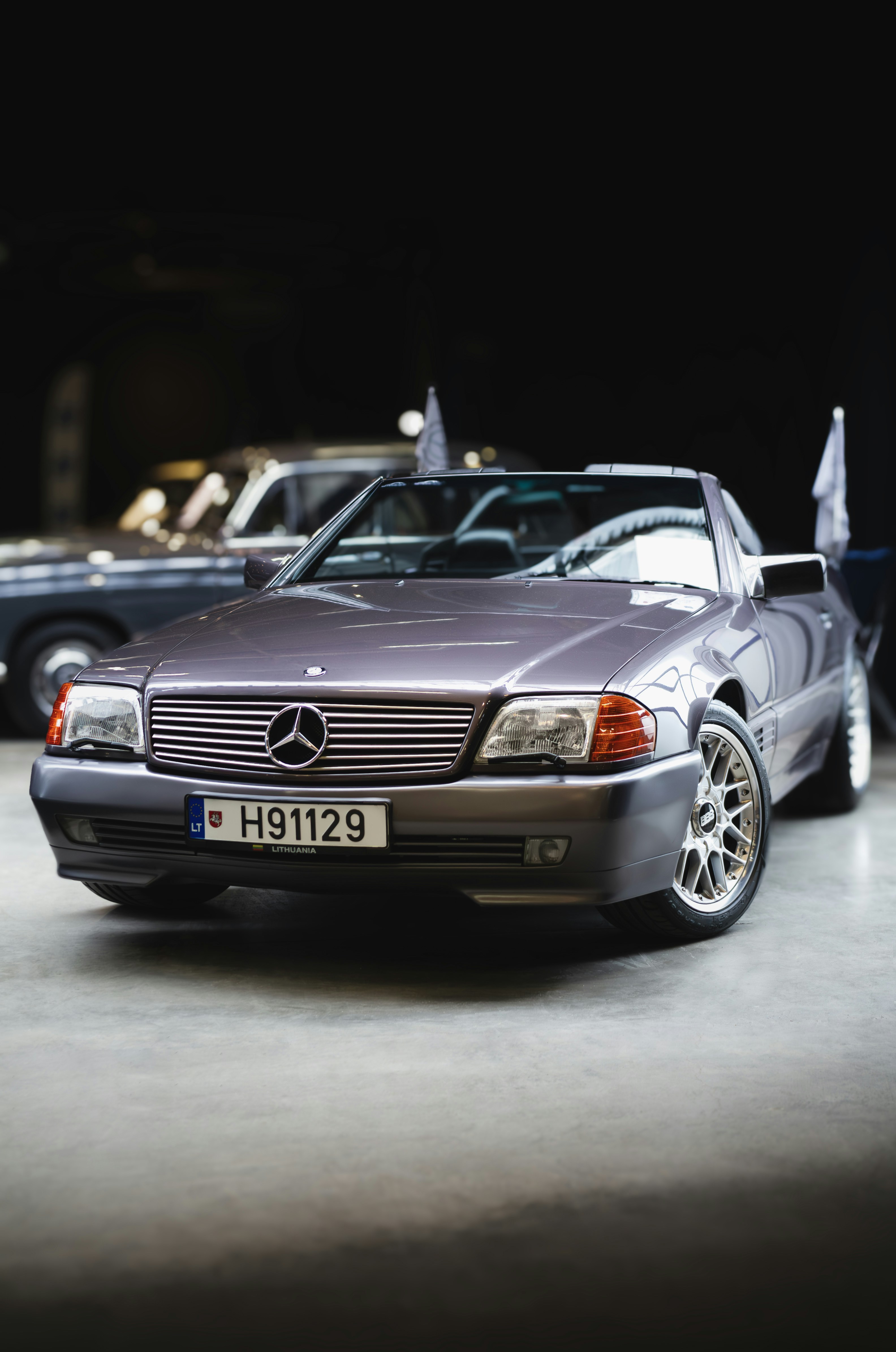 Midnight Mercedes: A classic convertible waiting in the showroom glow