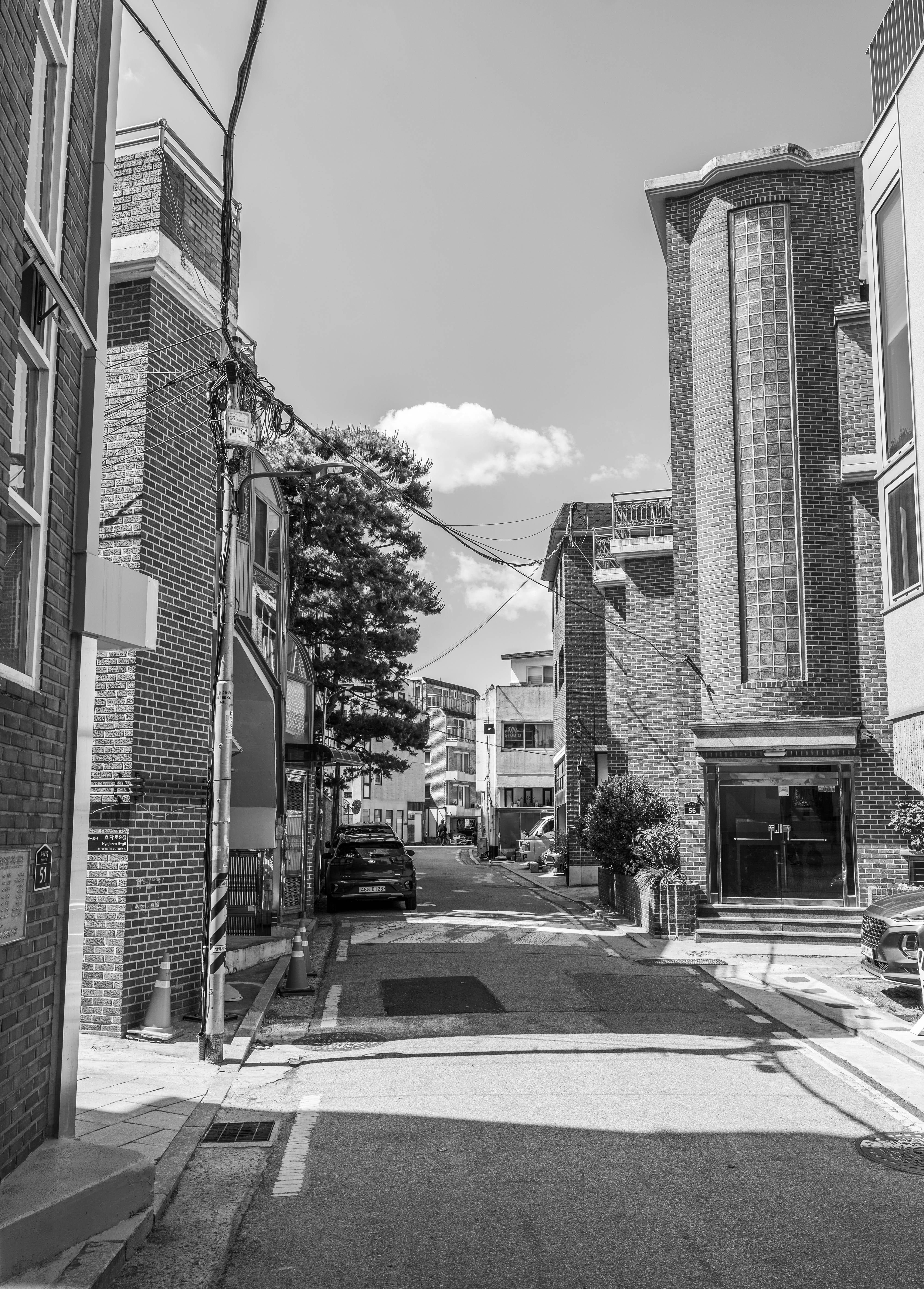 Urban alleyway in monochrome: guiding light through brick canyons