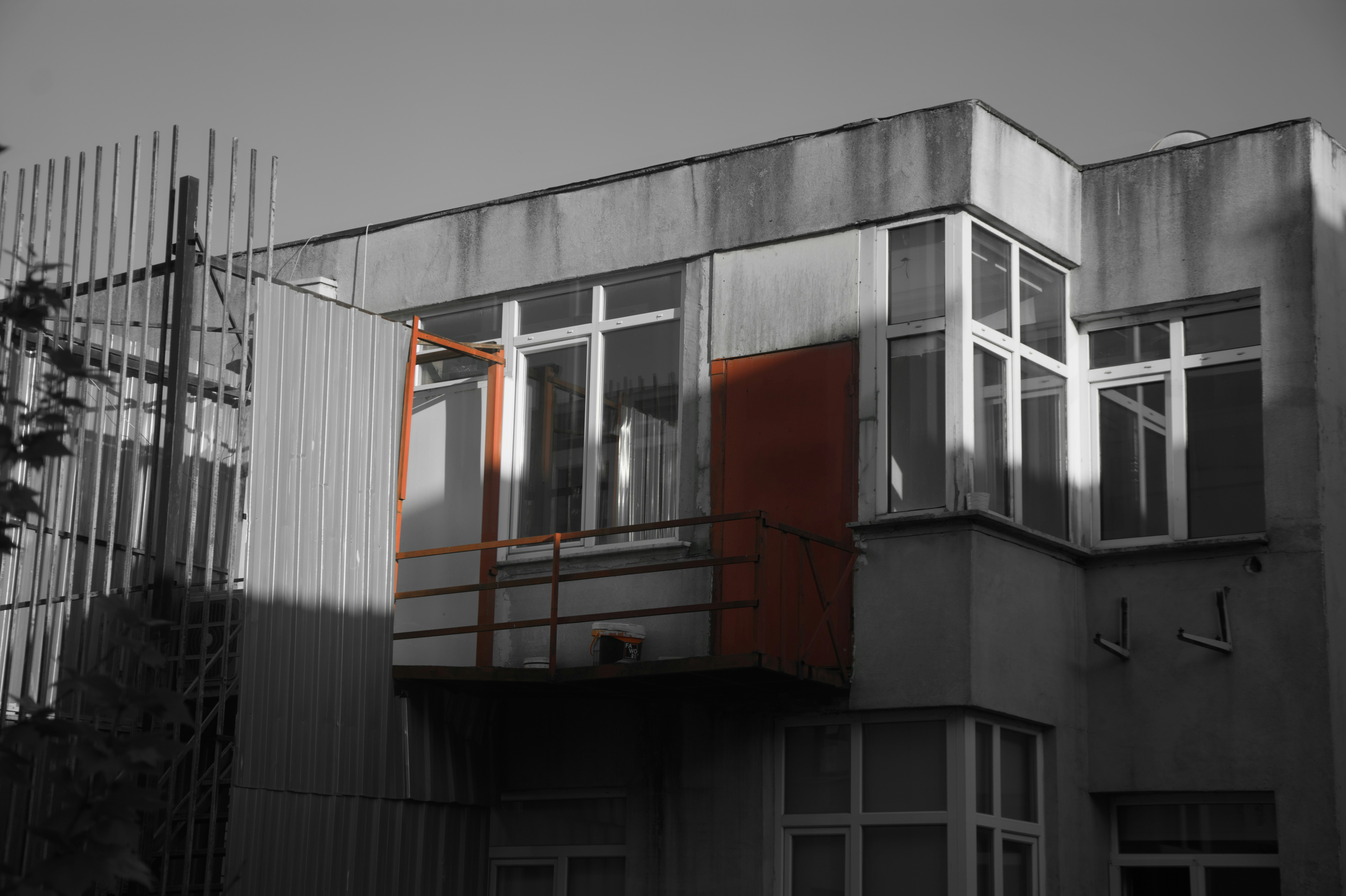 Concrete Balcony in Shadows: An Industrial Facade in Monochrome