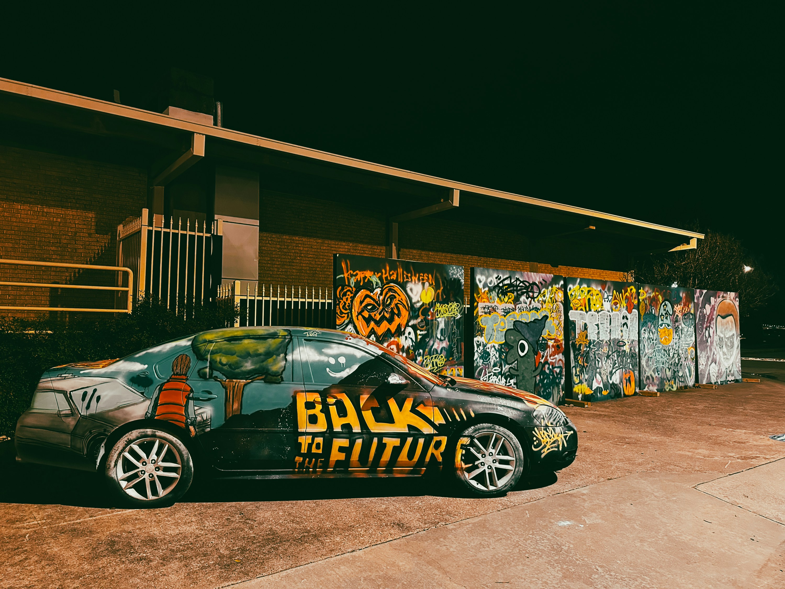 Graffiti Gallery Drift: A customized 'Back to the Future' car under muraled night