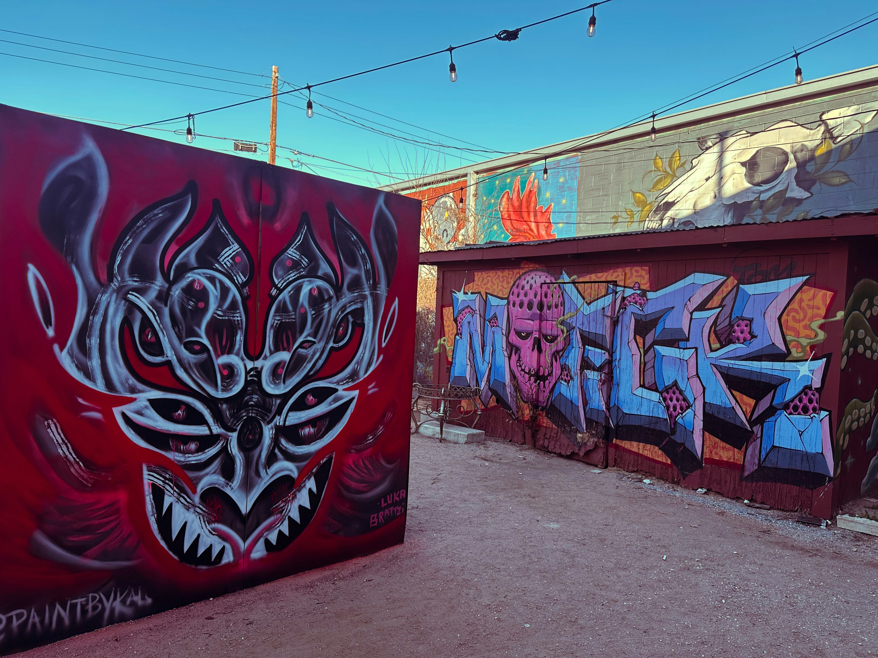 Graffitied Alley: Faces, Flames and Neon Letters