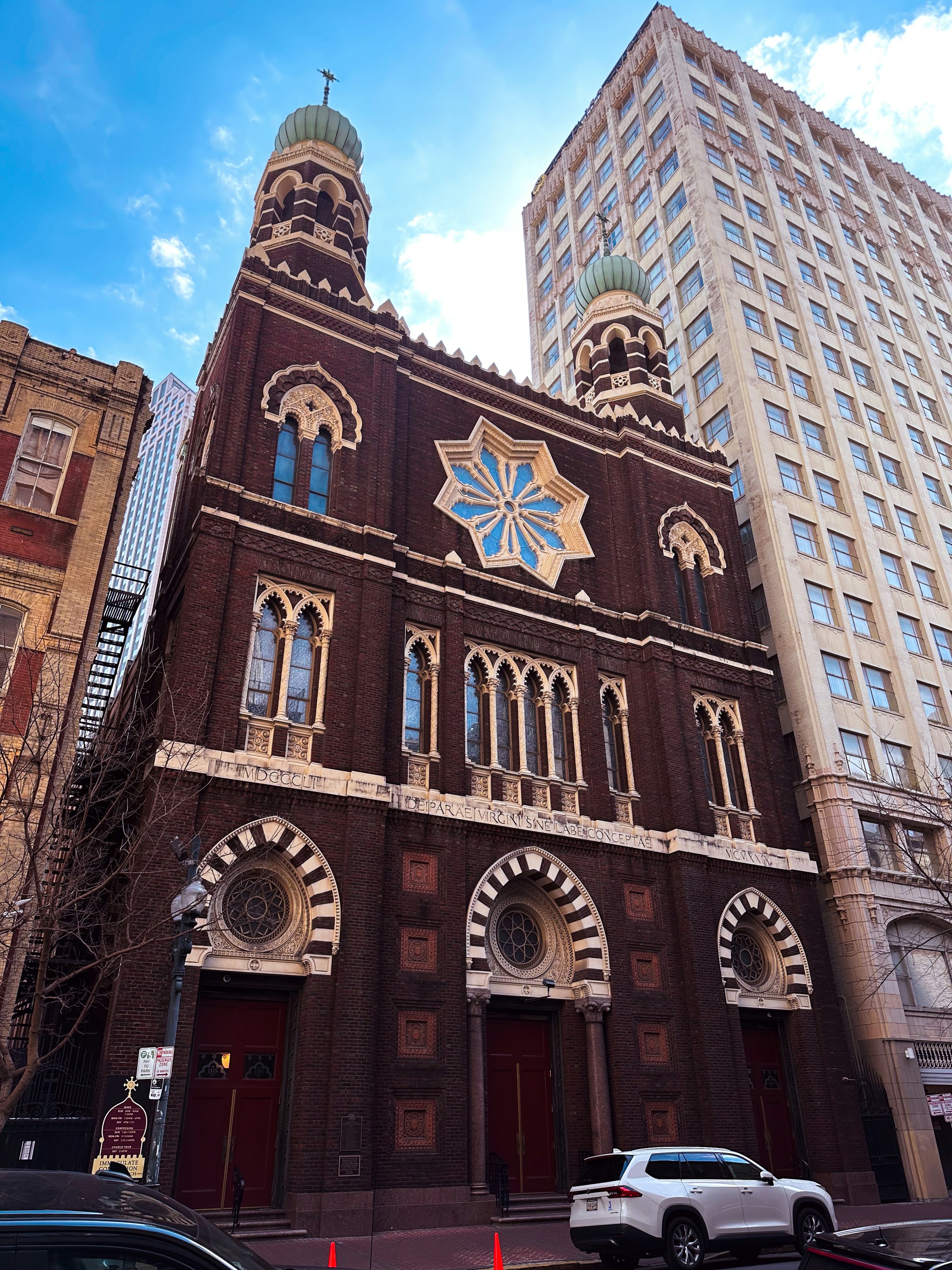 Neo-Gothic Facade Rising Between Steel Giants