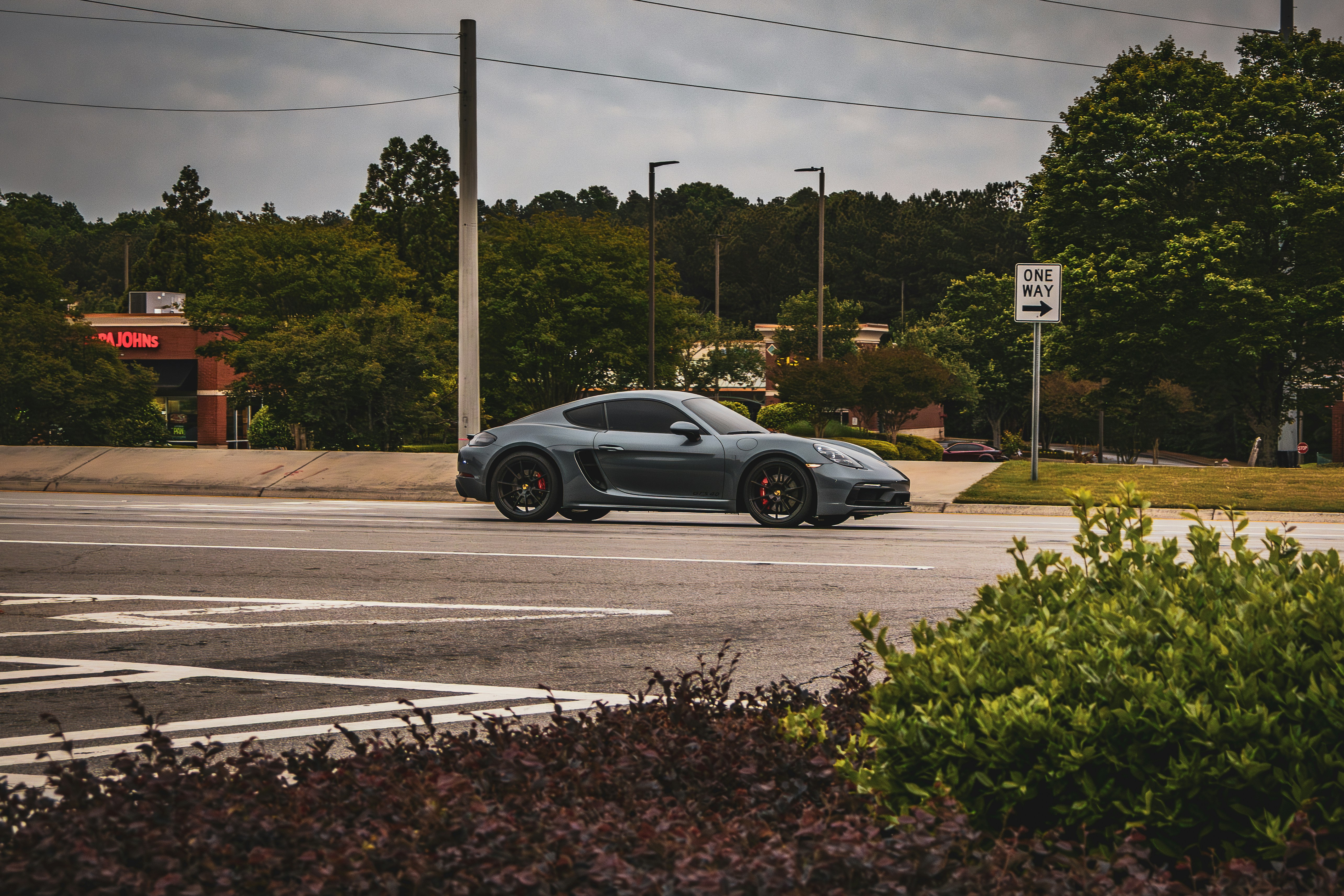 Midtown Midnight: A sleek coupe resting along a sunlit suburban road