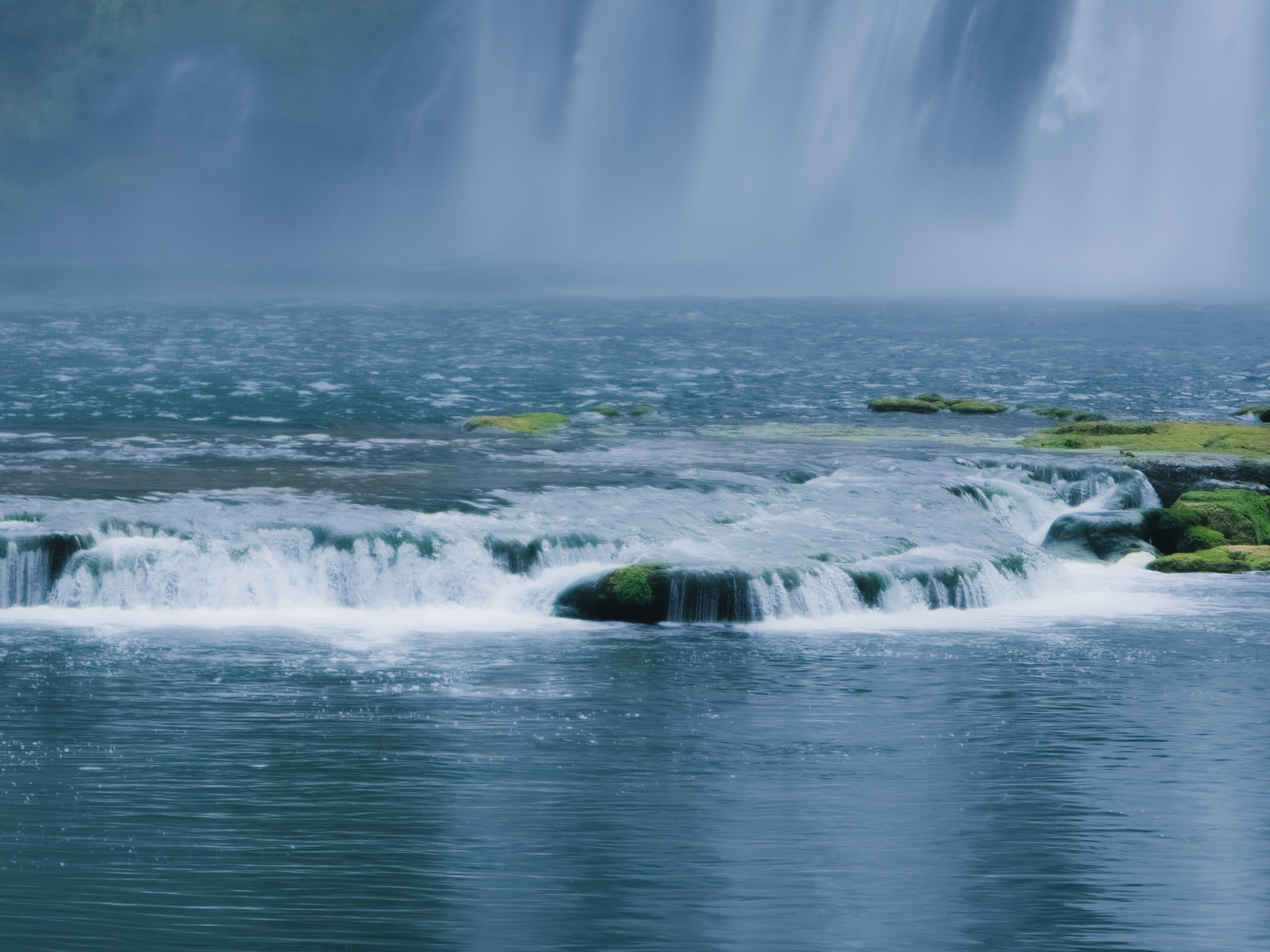 Mist-veiled Falls: A Quiet Confluence Over Blue Currents