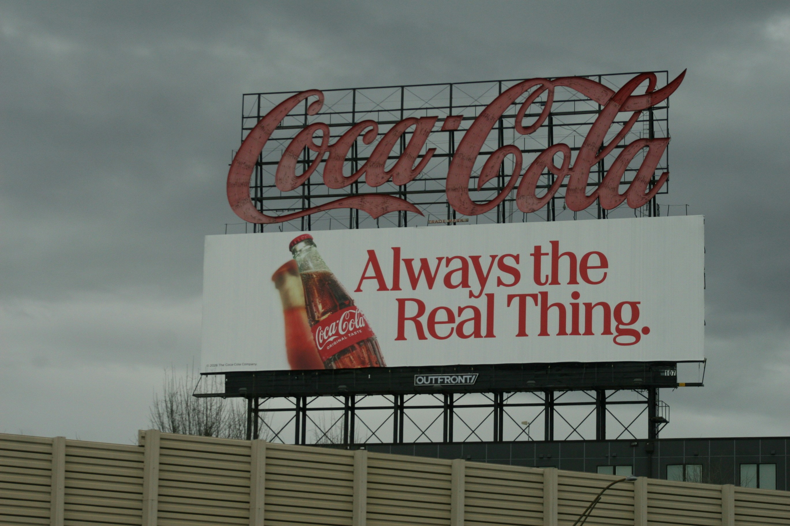 Coca-cola billboard with slogan always the real thing.