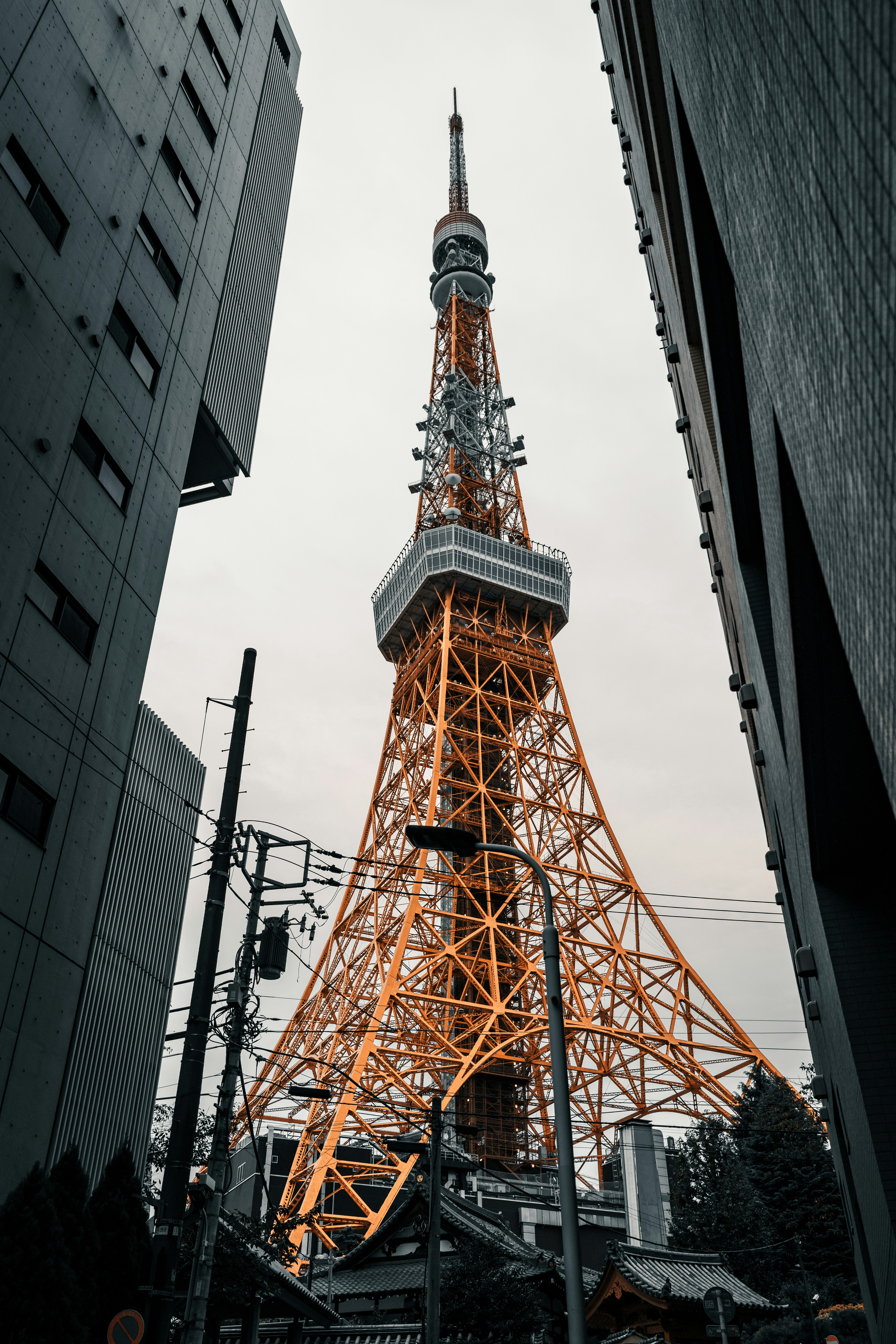 Tokyo Tower Rises Through a Narrow Urban Canyon