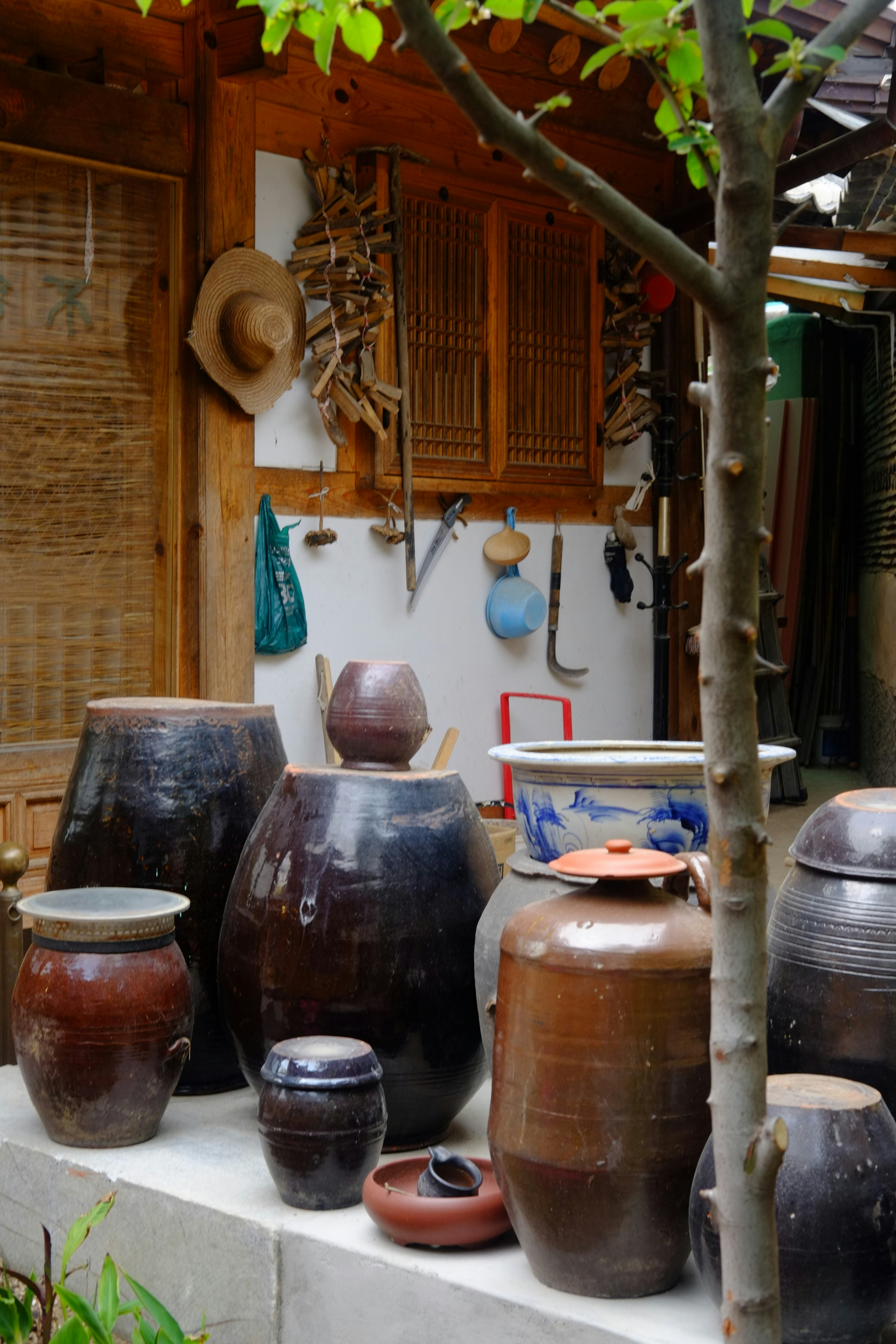 Clay Jars and Wooden Workshop on a Shaded Courtyard