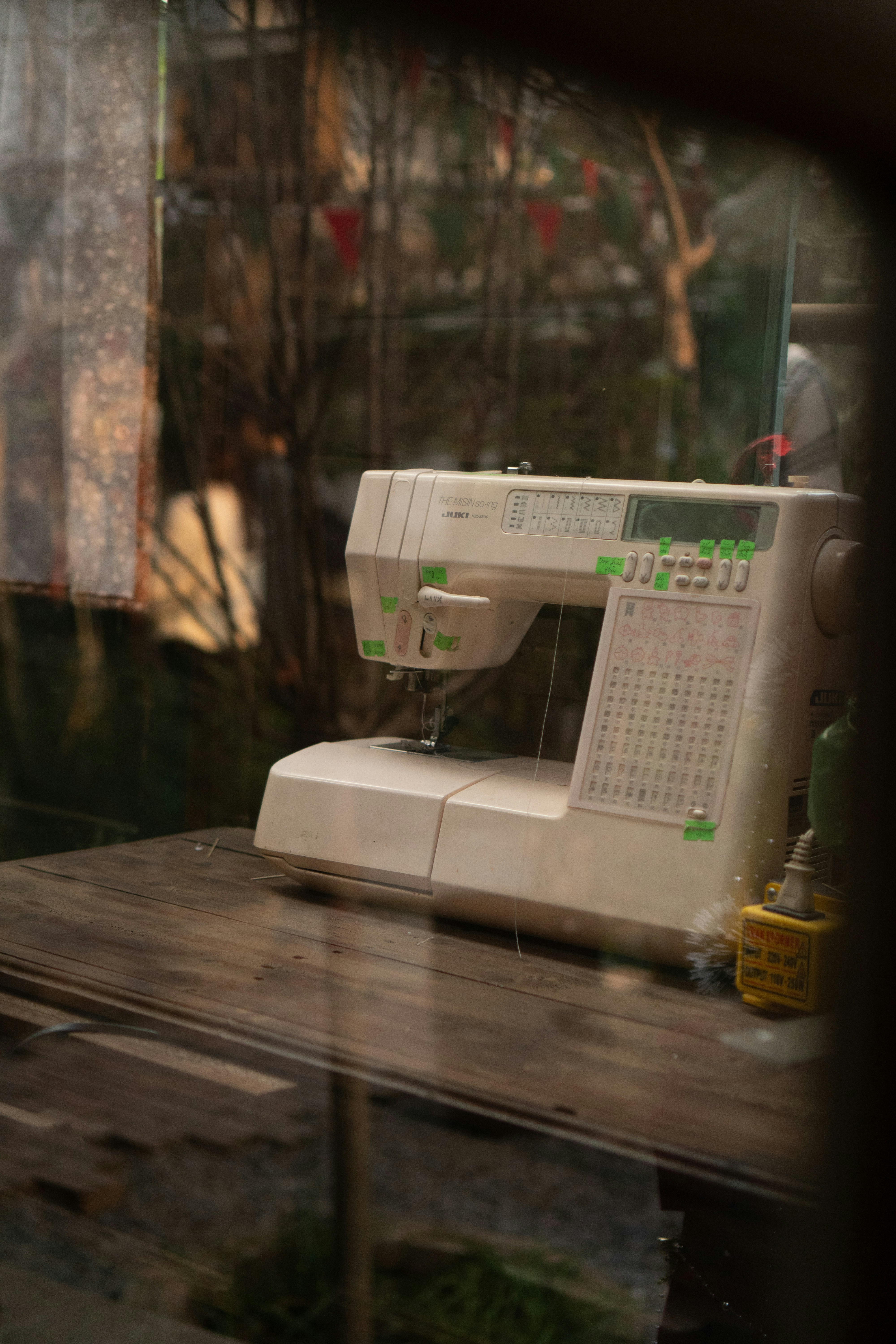 A Quiet Workbench: Vintage Serger with Green Accents in Soft Light
