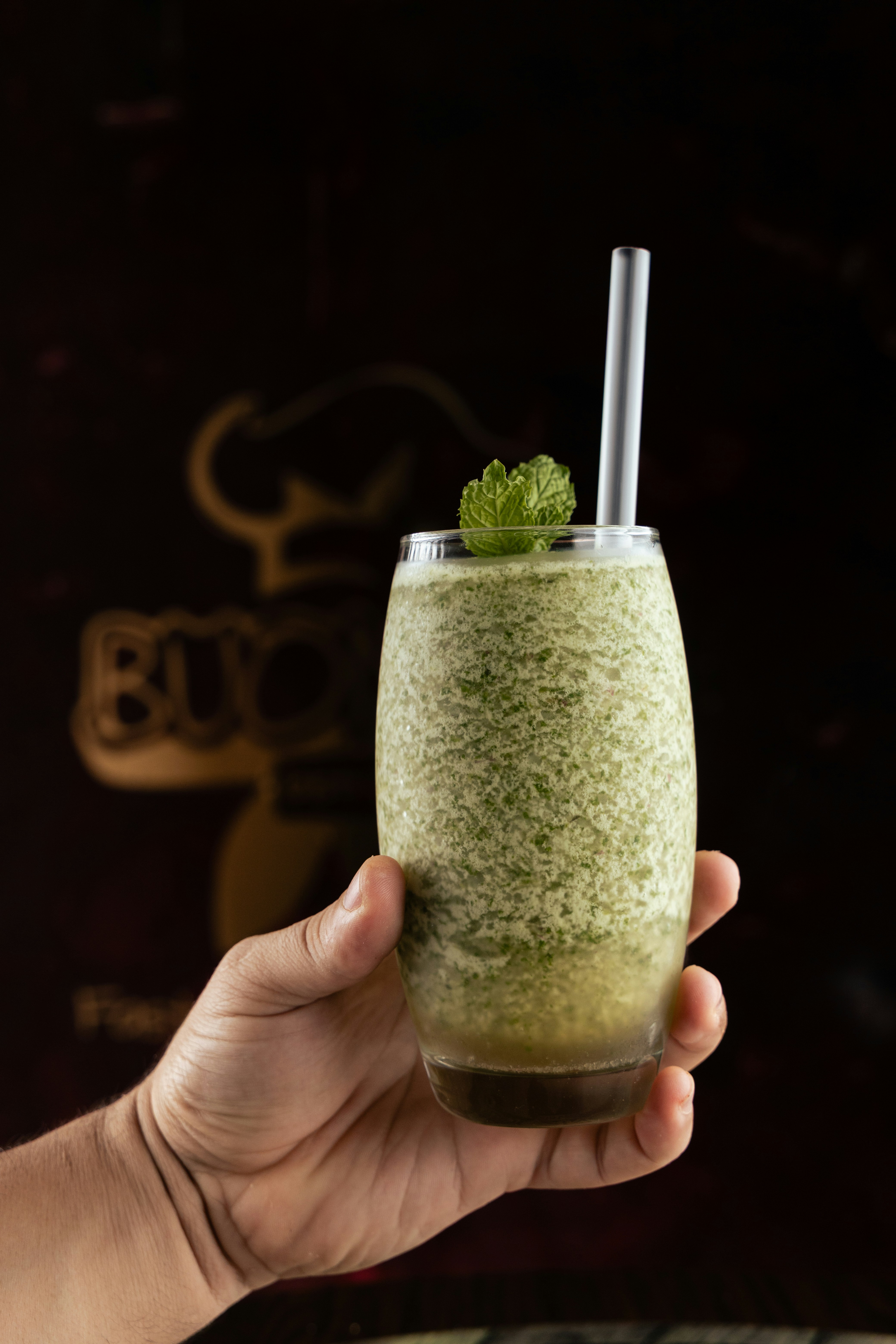 Green Elixir in Hand: A Minty Moment of Refreshment