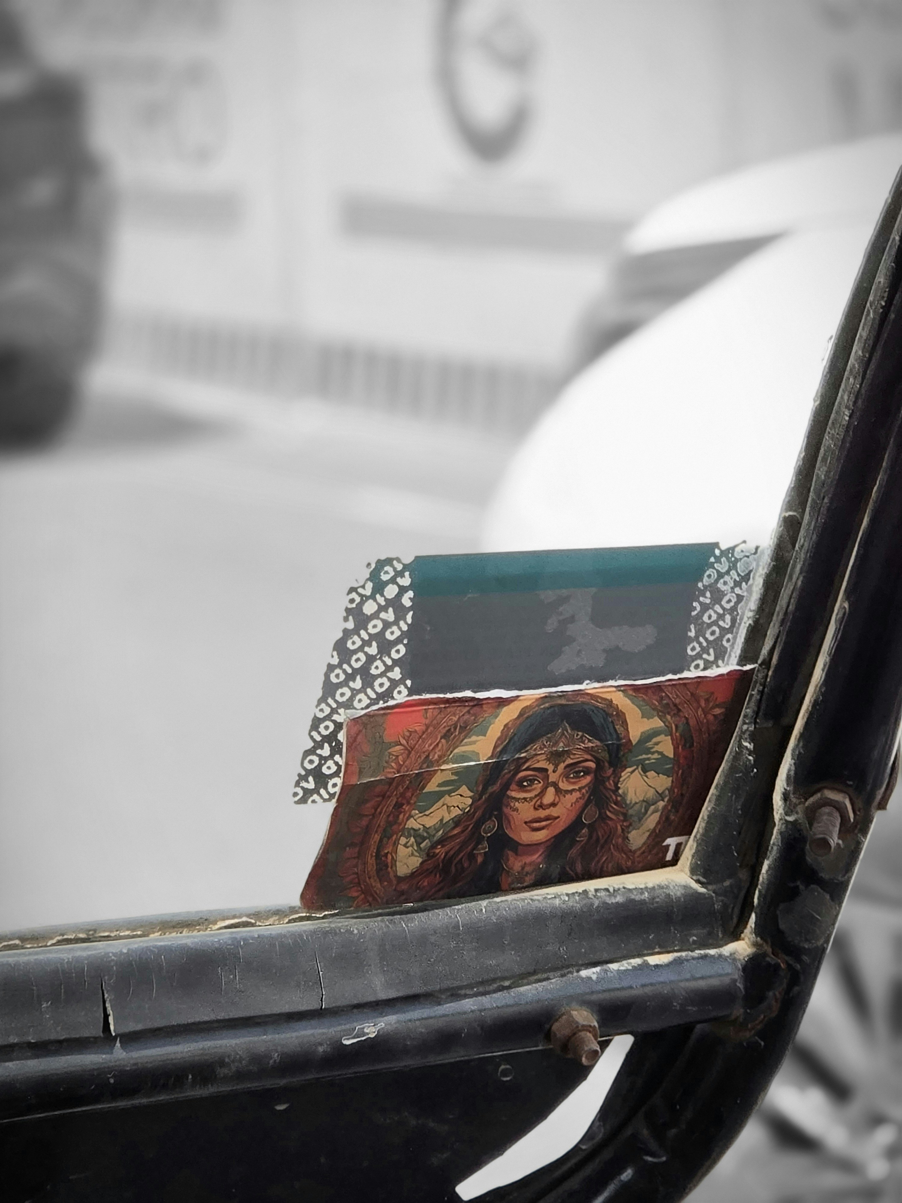 Stickered Portrait Pegs the Frame of a Weathered Vehicle