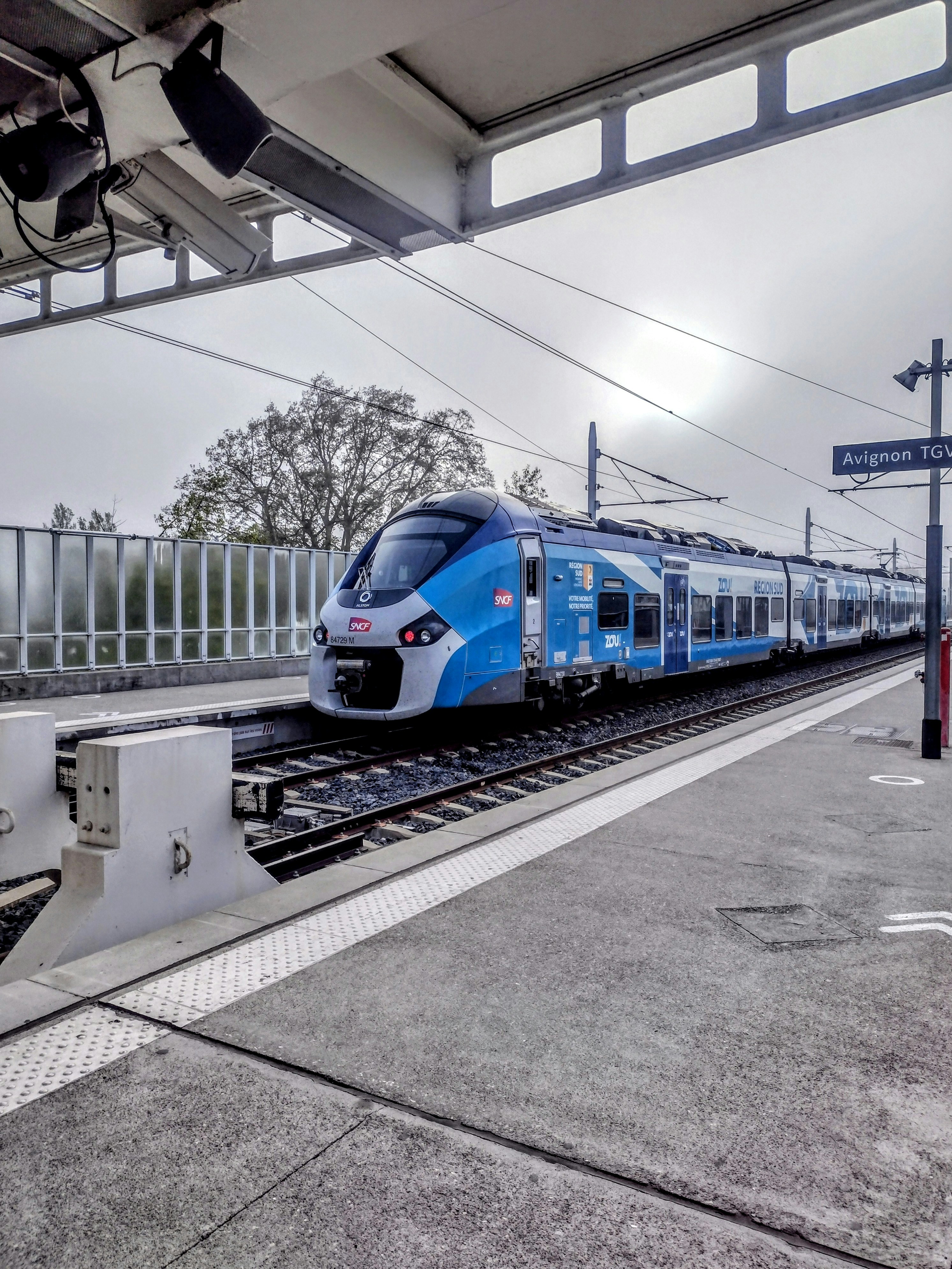Blue Commuter: A Sunlit Train Rests at Avignon Station