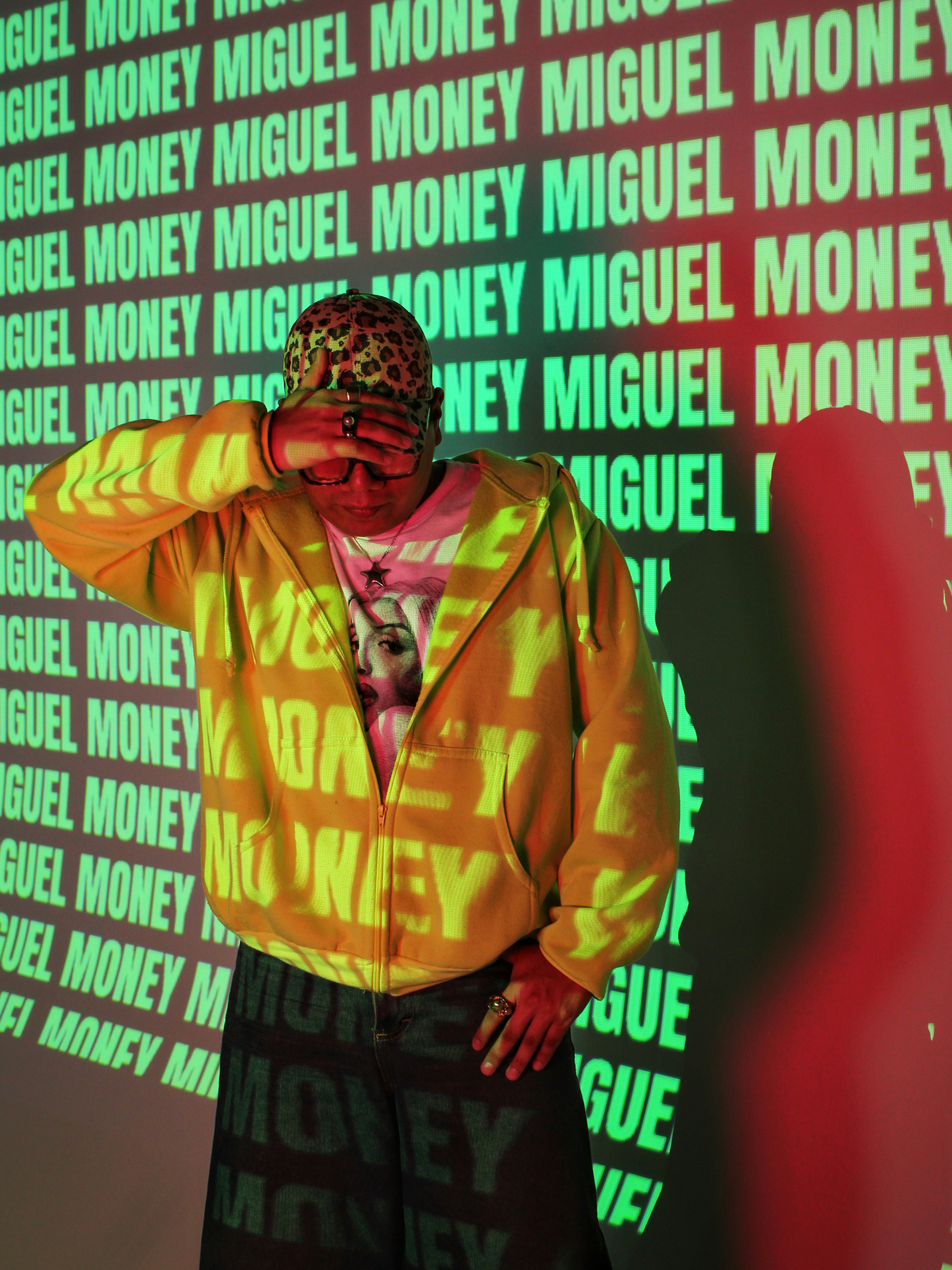 Neon Wall, Bold Stance: A Portrait Under Repeating Moneymoji