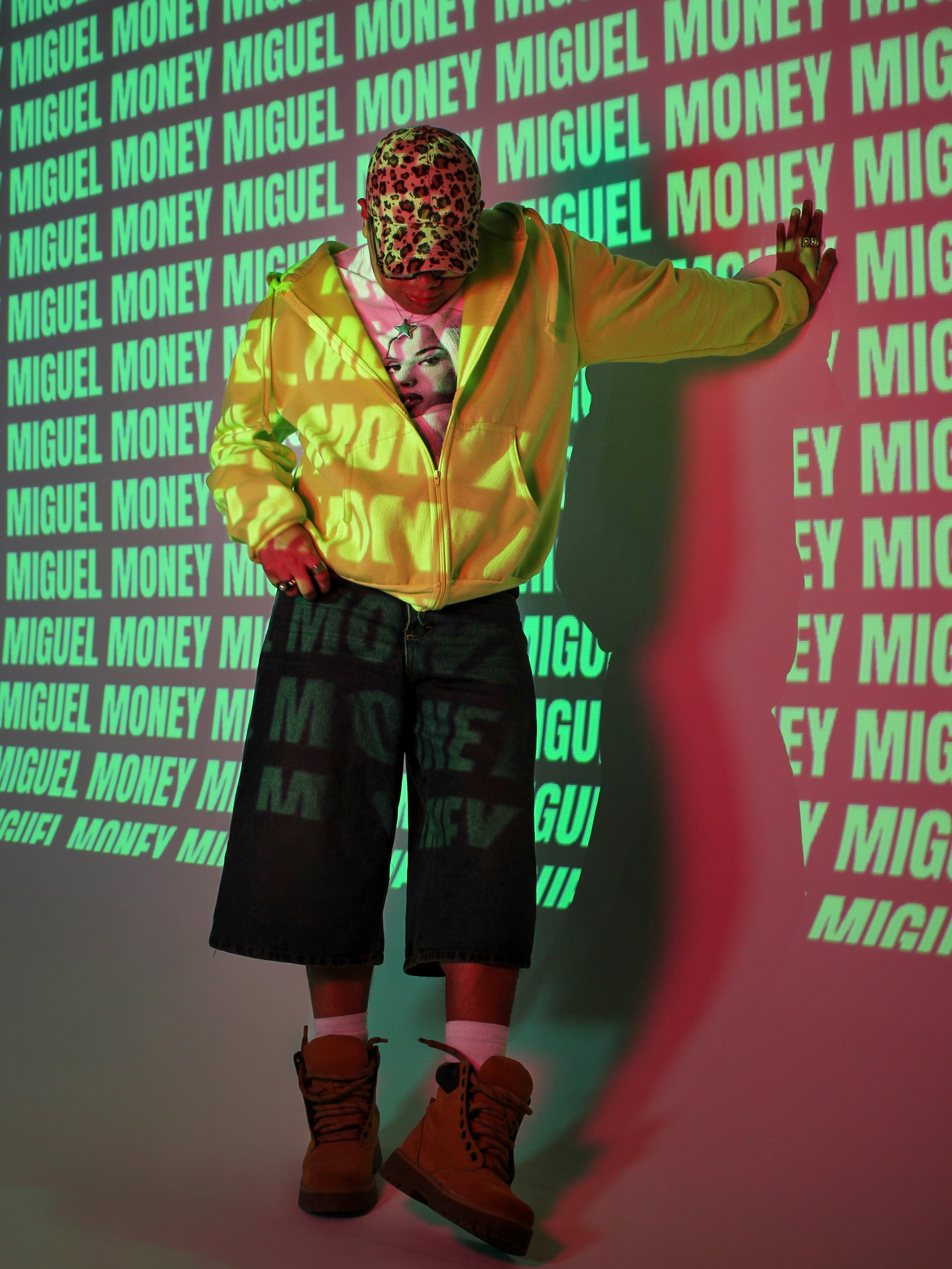 Neon Projection Portrait: A Neon-Washed Performer in a Leopard Cap