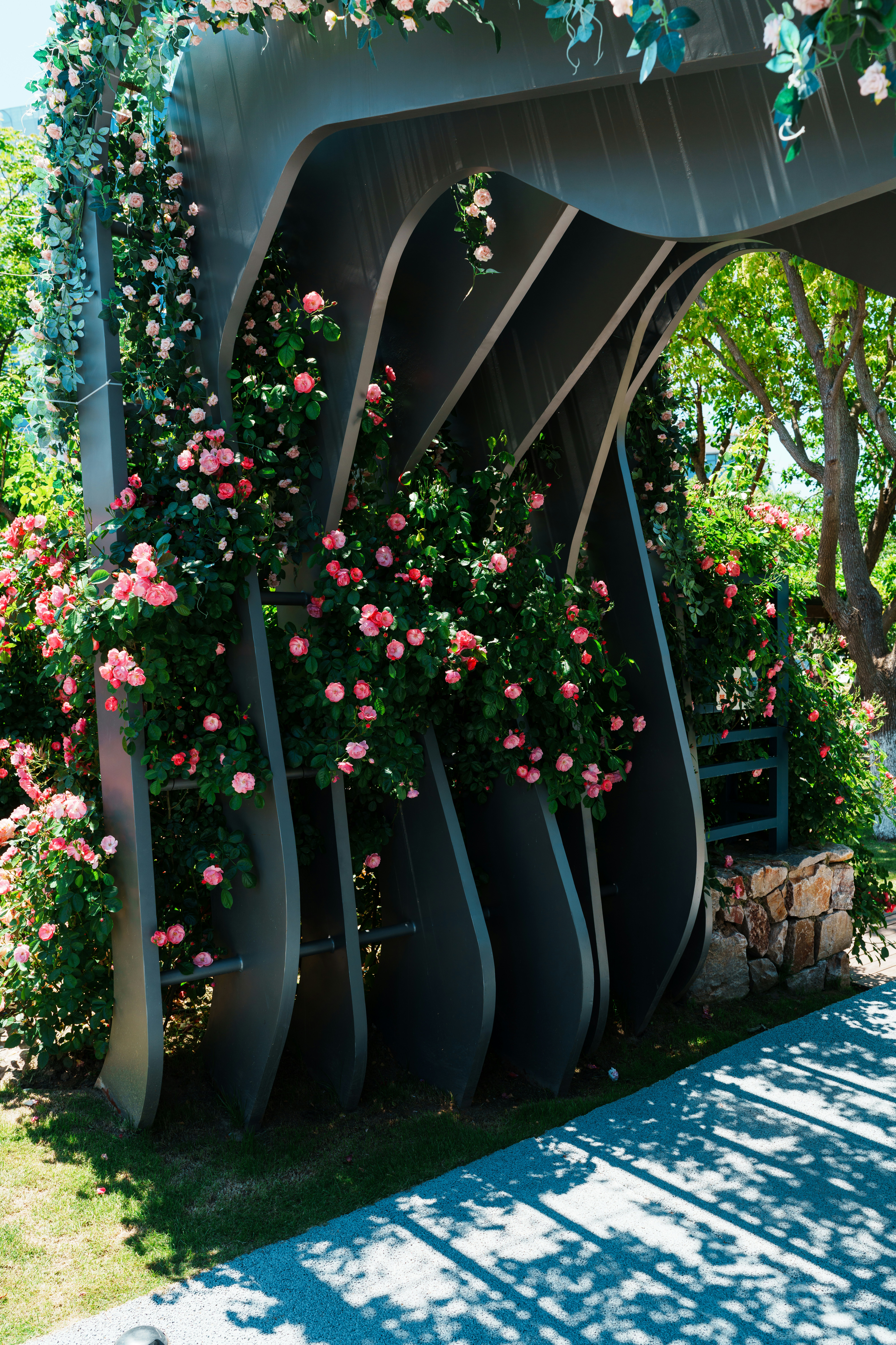 Petaled Archways: A Floral Steel Quilt Illuminated by Dappled Sun