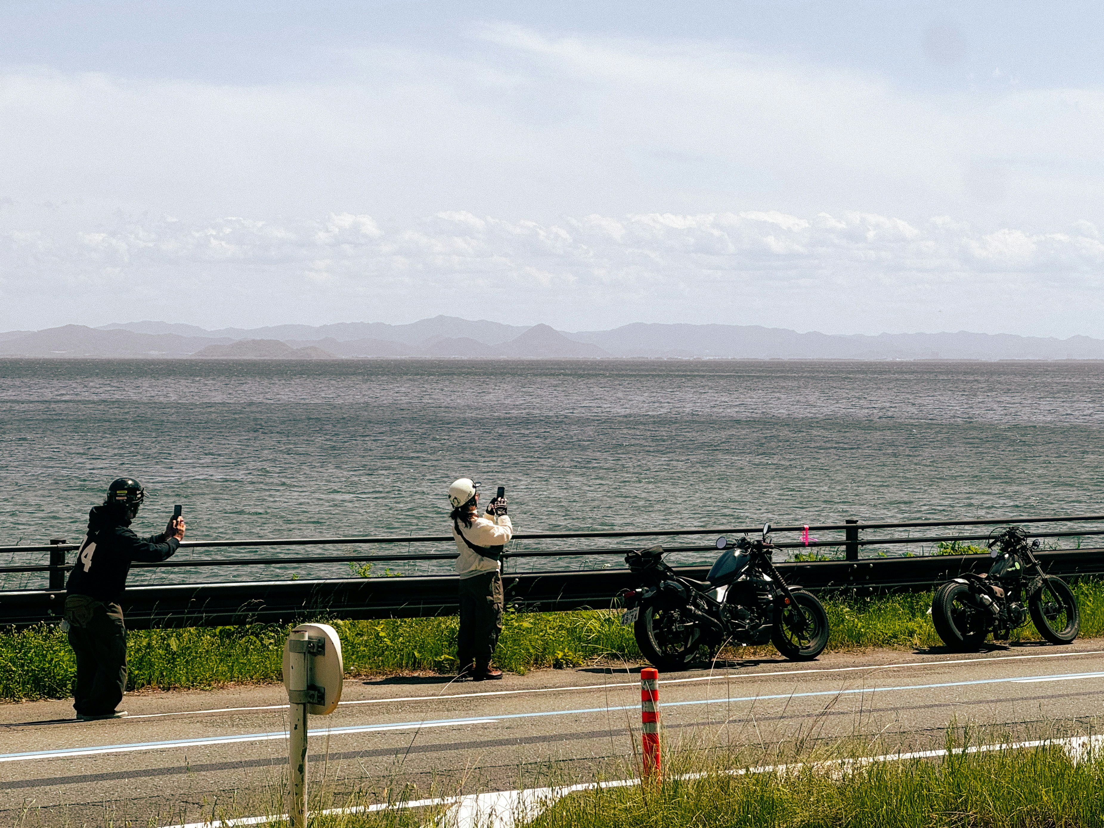 Coastal Motorcycle Stop: Riders Capture Moments by the Sea