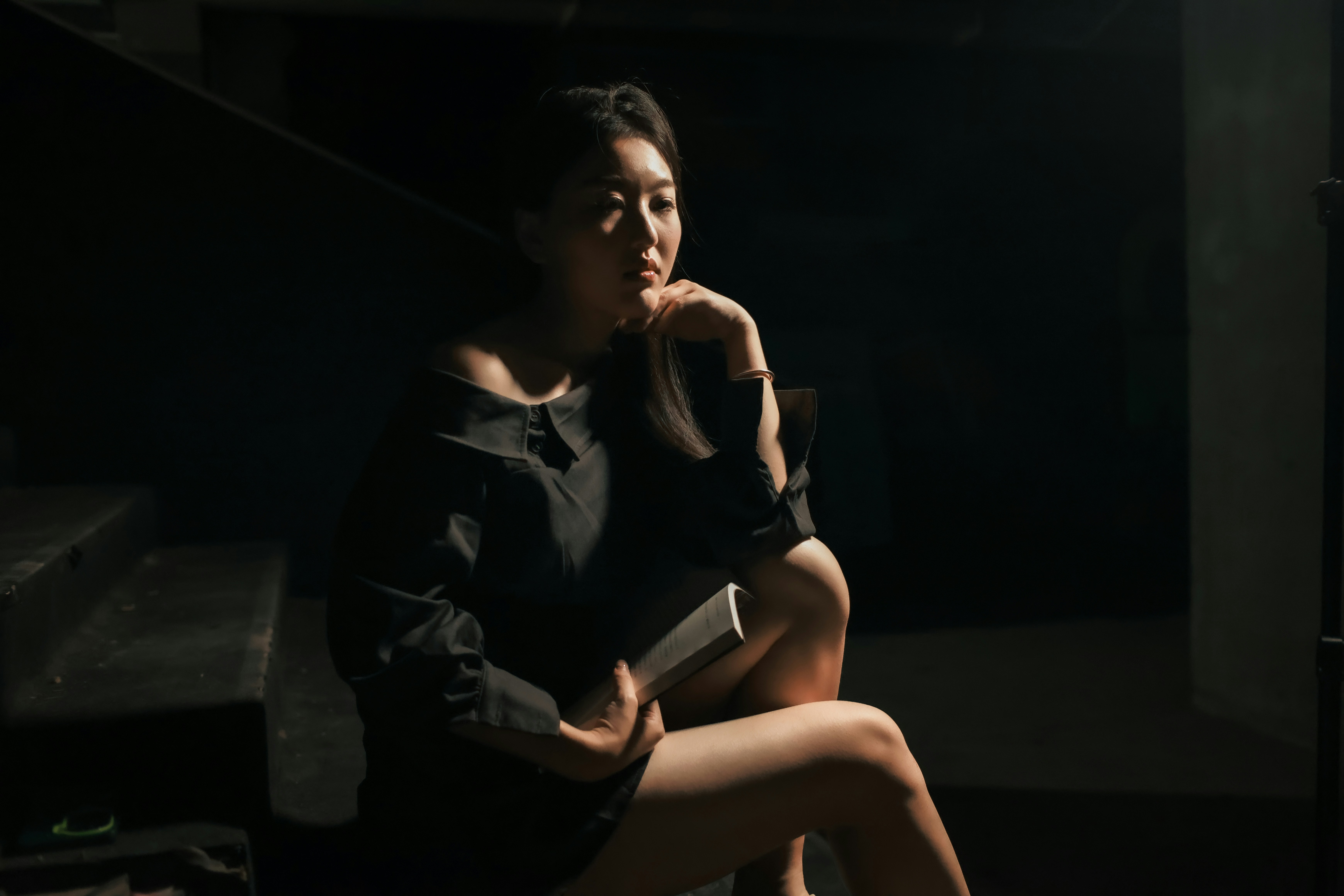 Muted Spotlight: A Quiet Portrait in a Dark Studio