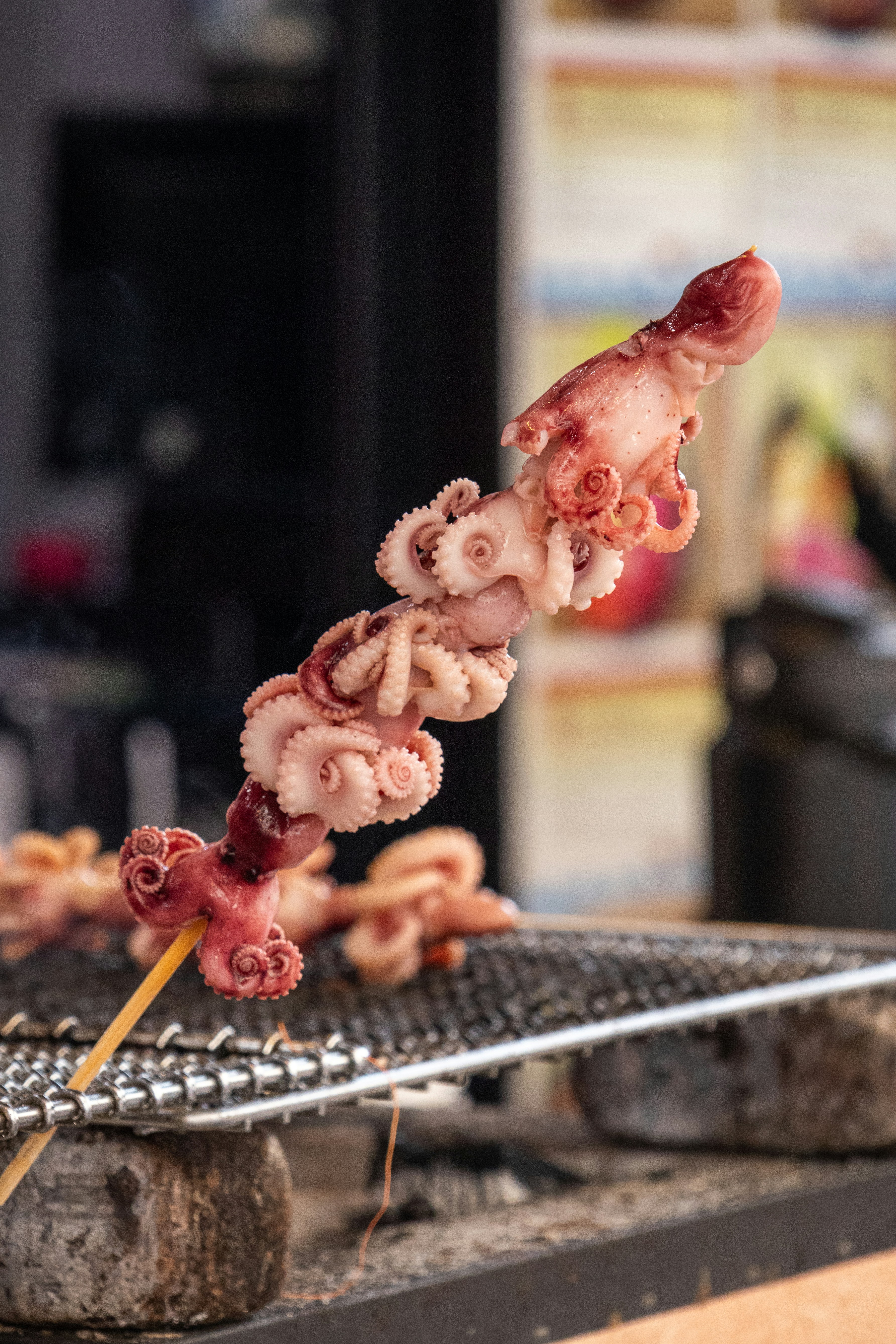Tentacled Skewer: Pink Octopus Charms a Street Grill