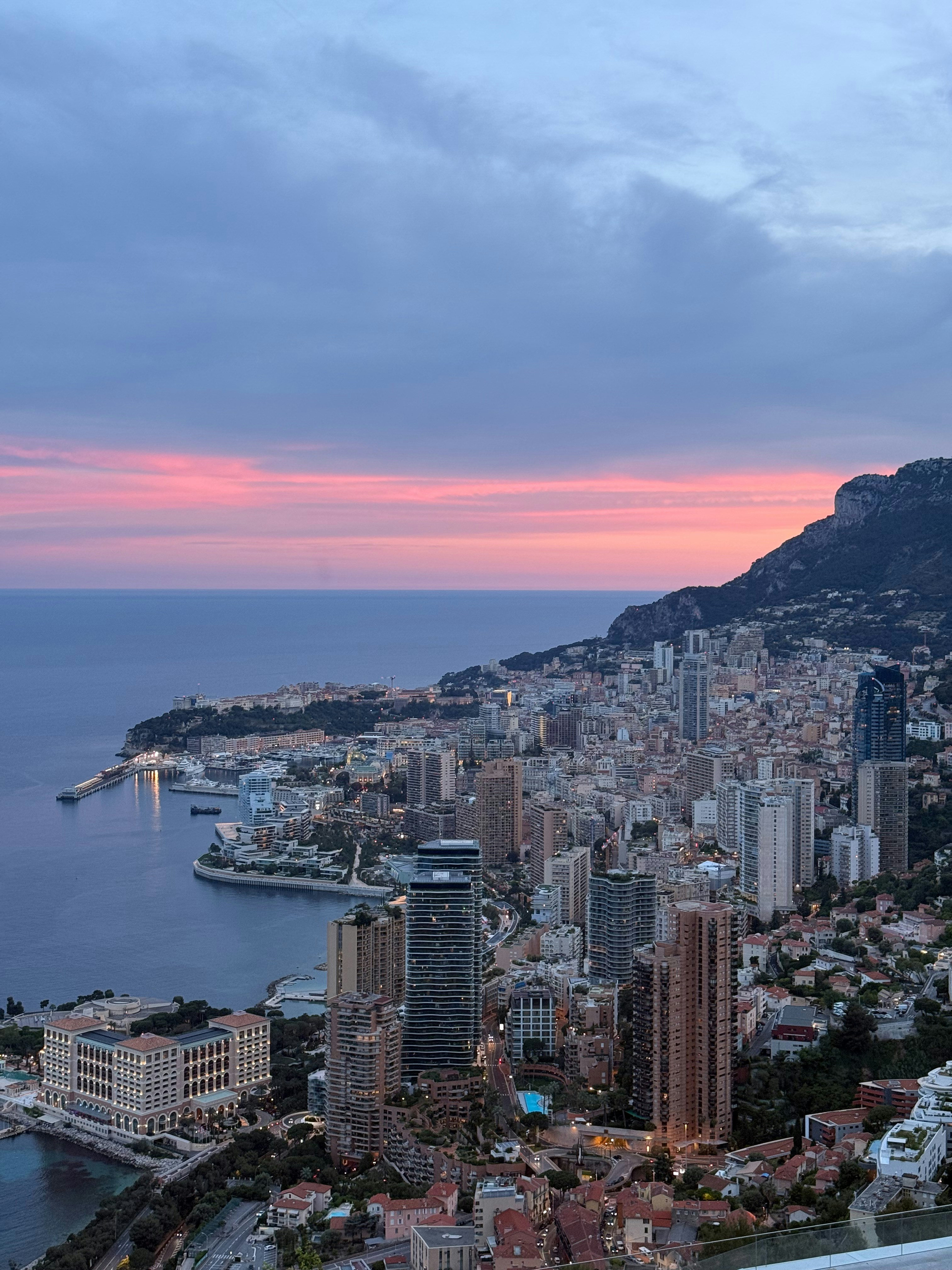 Sunset Over a Terraced Metropolis Along the Rocky Coast