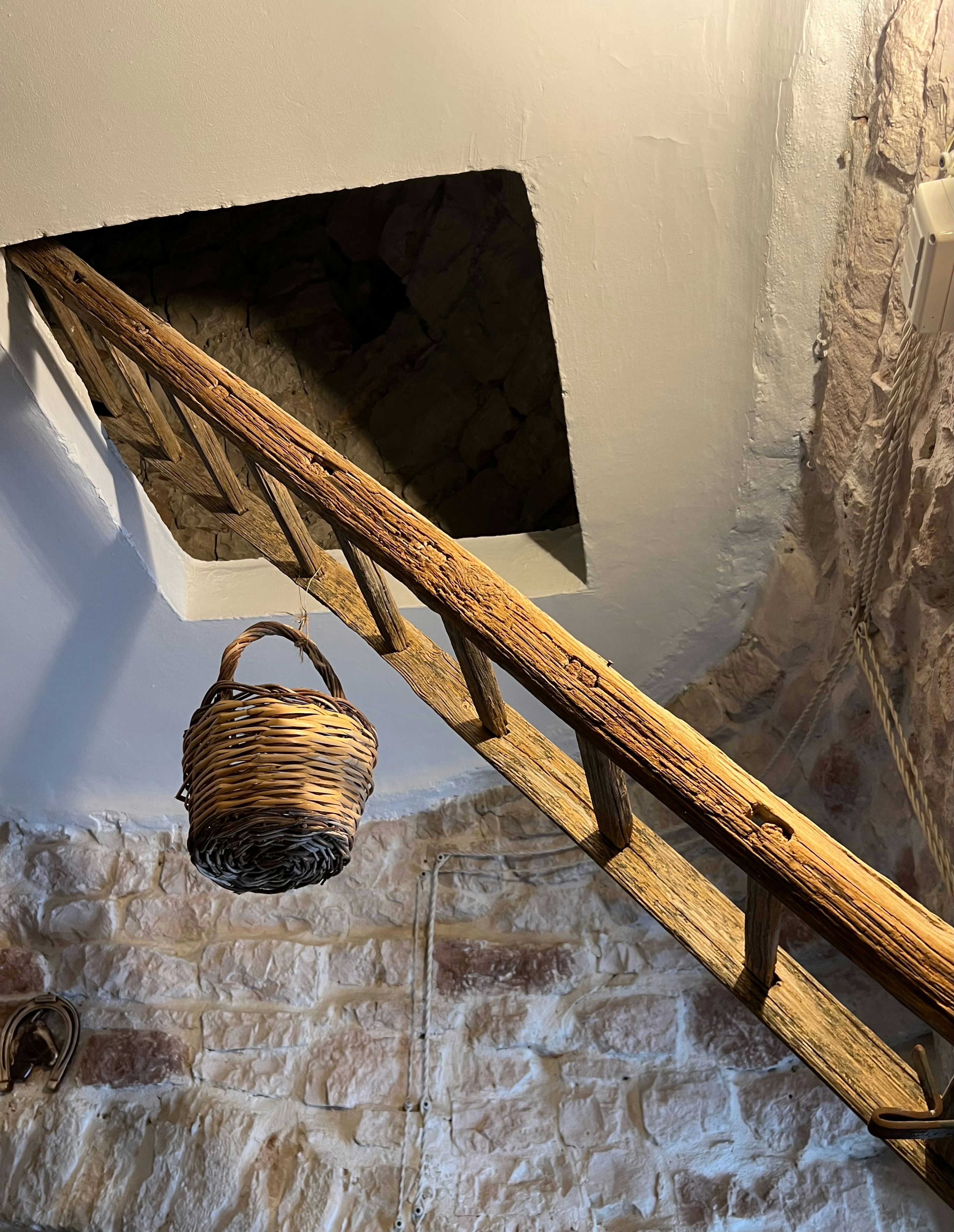 Basket and stairway in a rustic stone stairwell