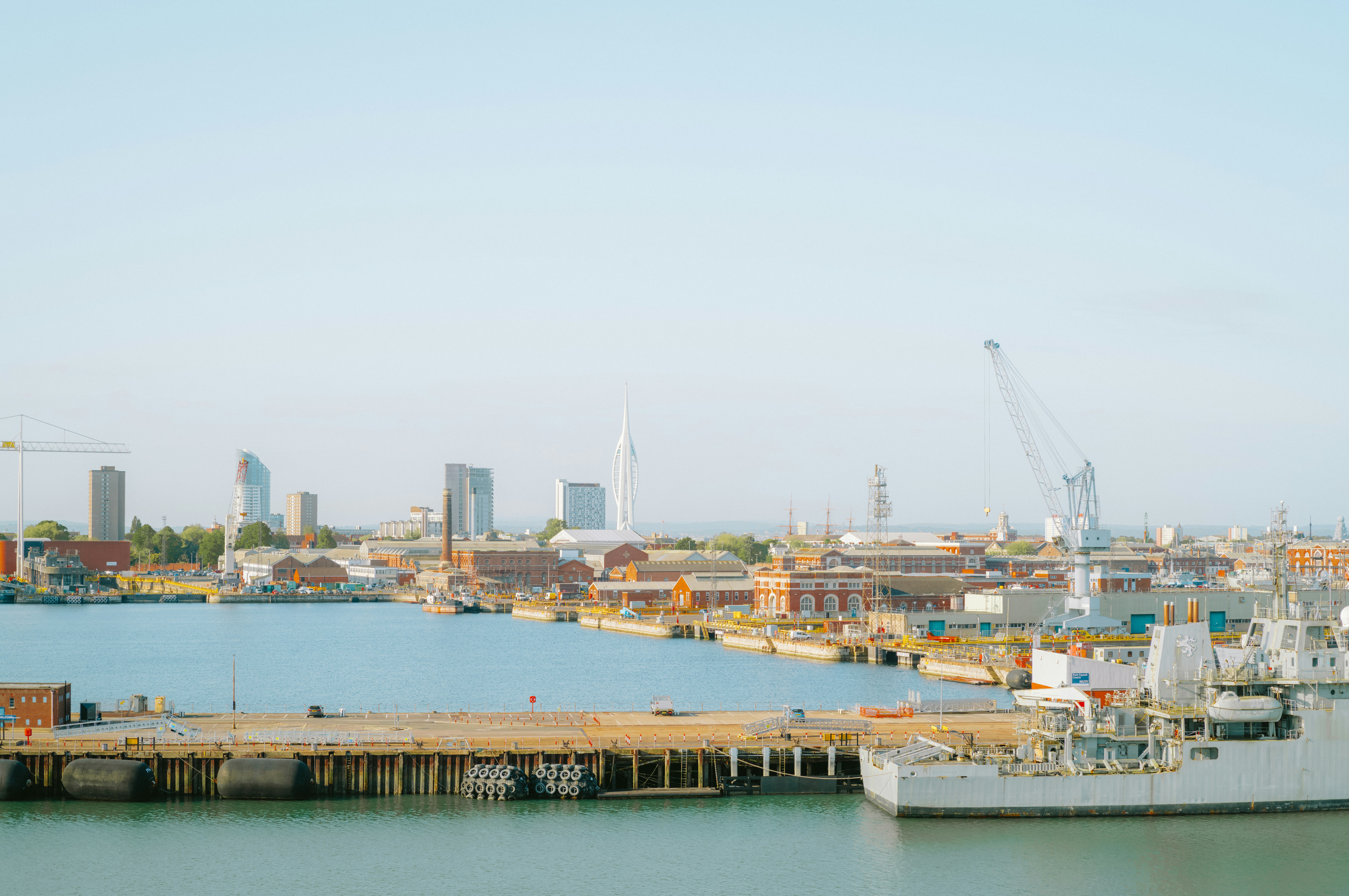 Harbor Wake: A Slice of Maritime Calm and Cranes