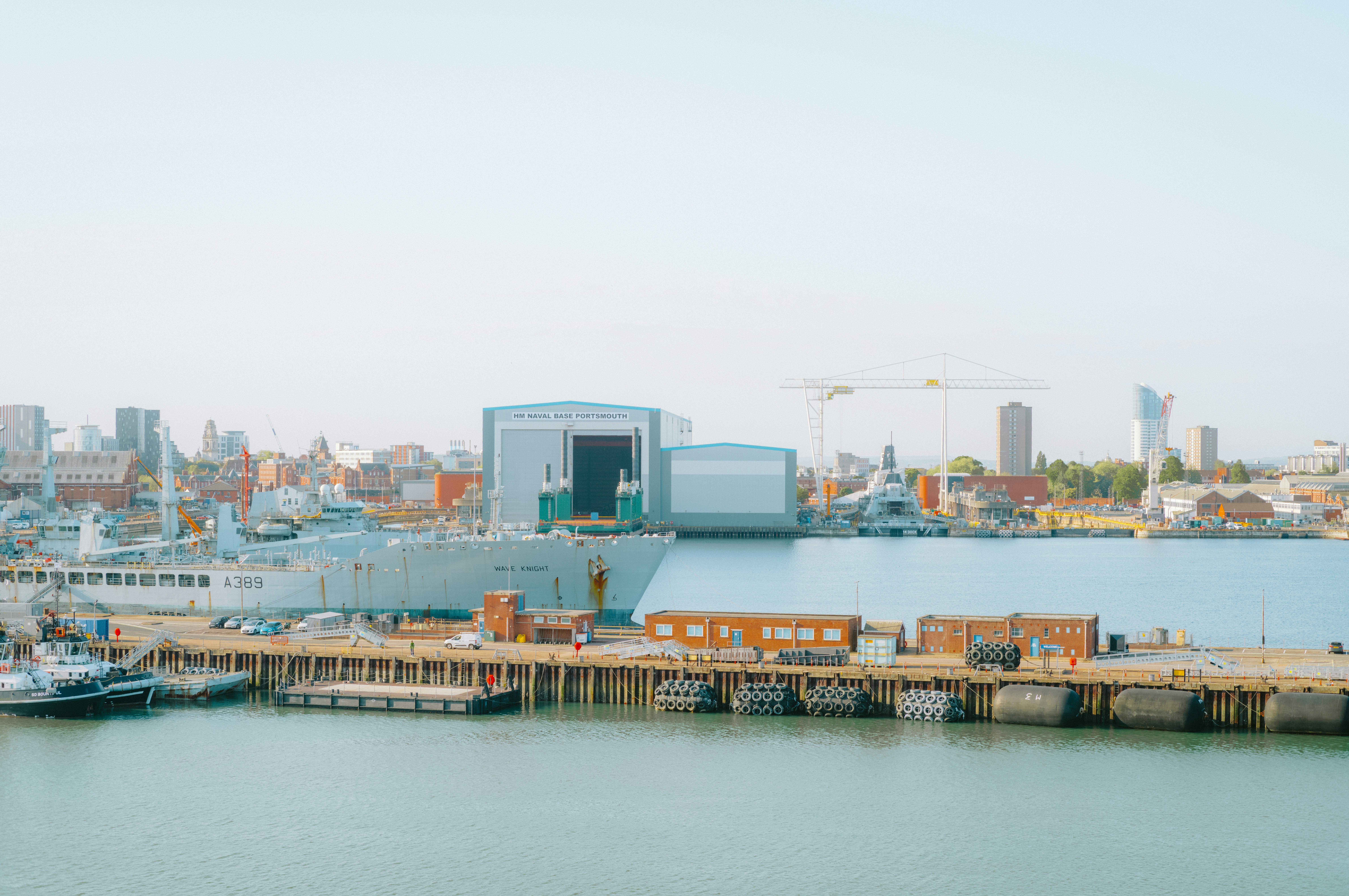 Dockyard Horizon: Cranes and ships at a calm harbor