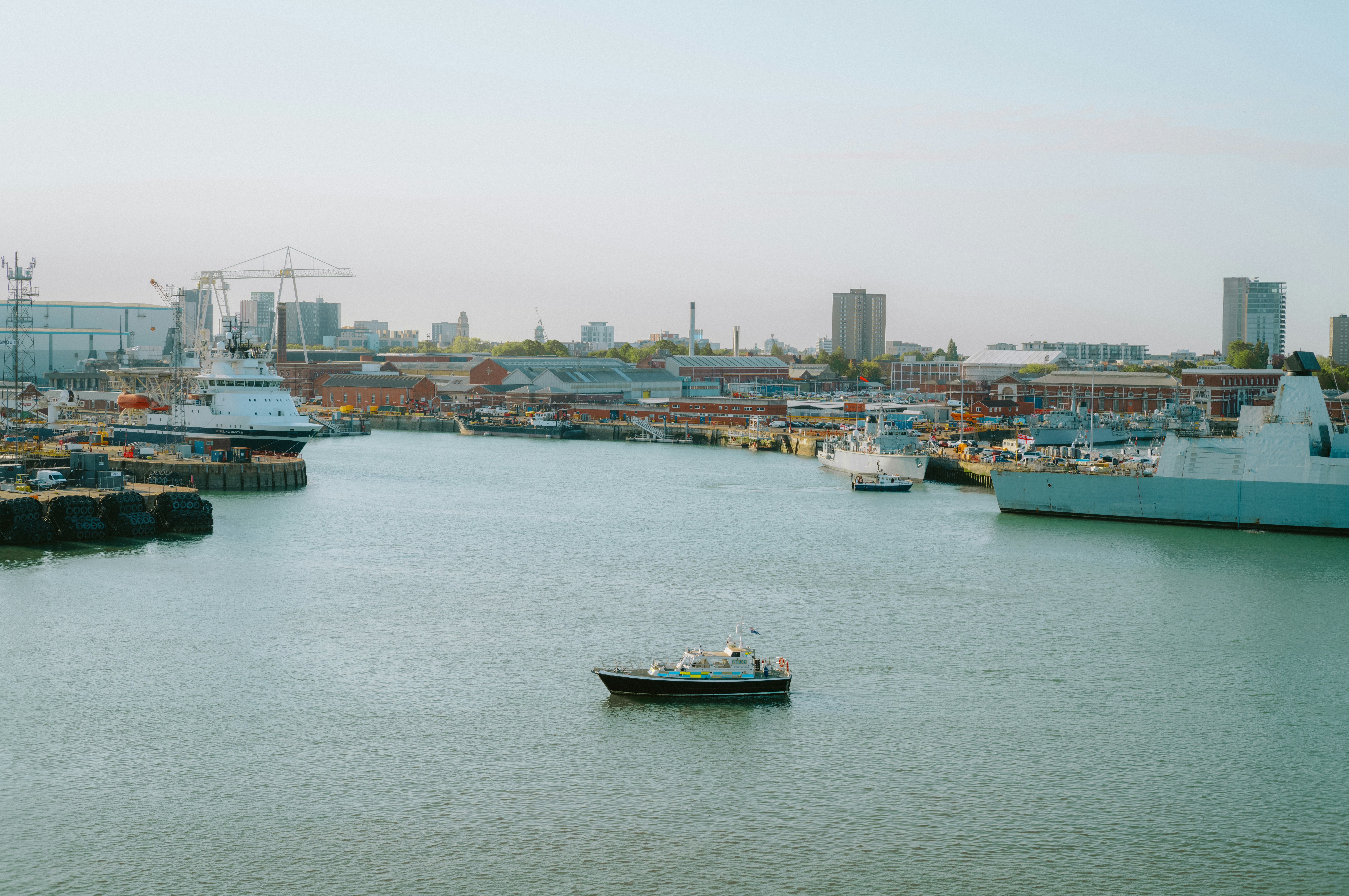 Harbor Anchor: A Quiet Boat Amidst a Distant Skyline