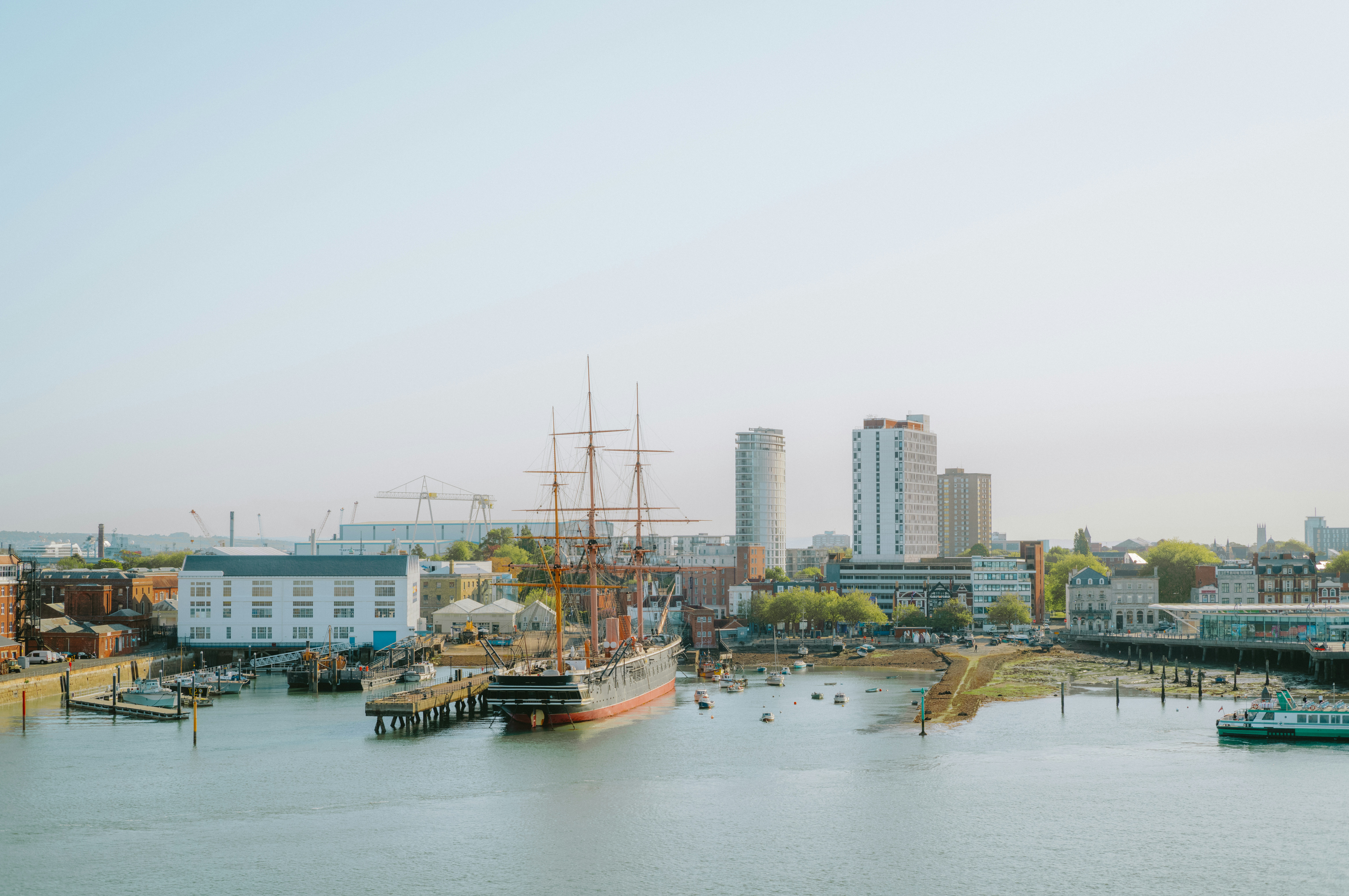 Harbor Verge: A Sailing Mast Framed by Modern Skyline