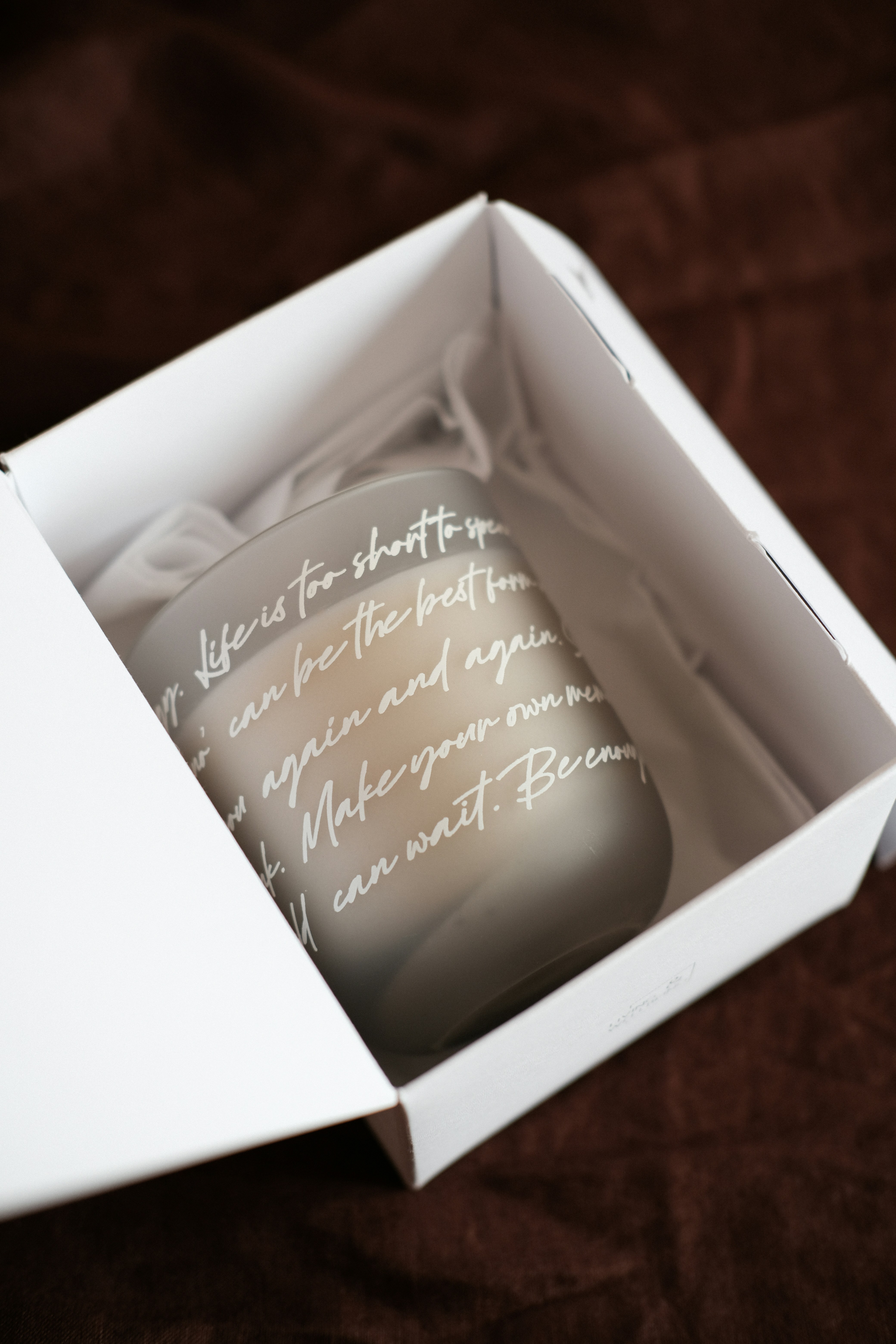 Echoes in a Gift Box: Scripted Matte Mug Beneath White Folds
