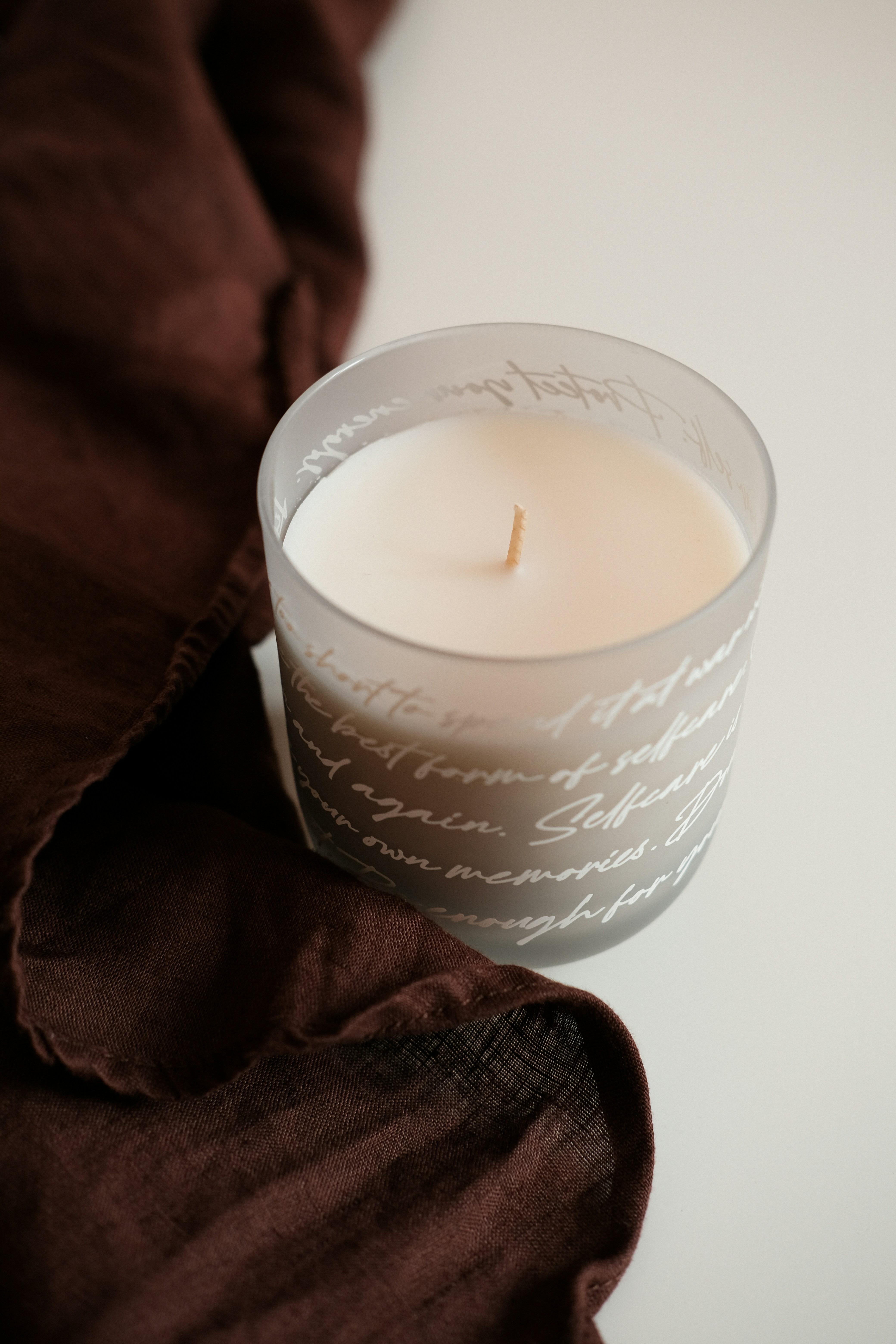 Minimal Candle Elegance on Soft Fabric