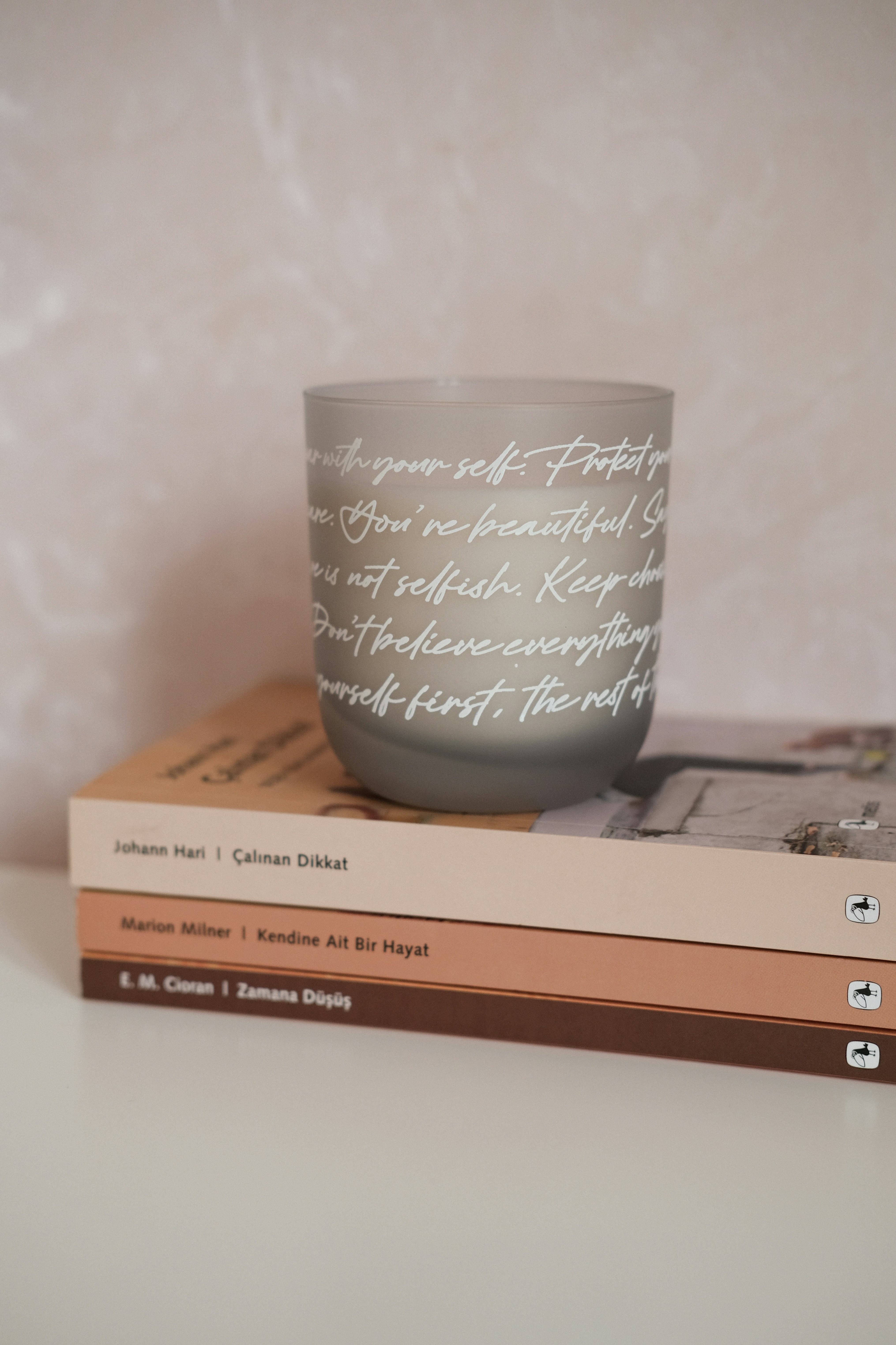 Steam Rising from a Matte Cup Resting on a Stack of Books